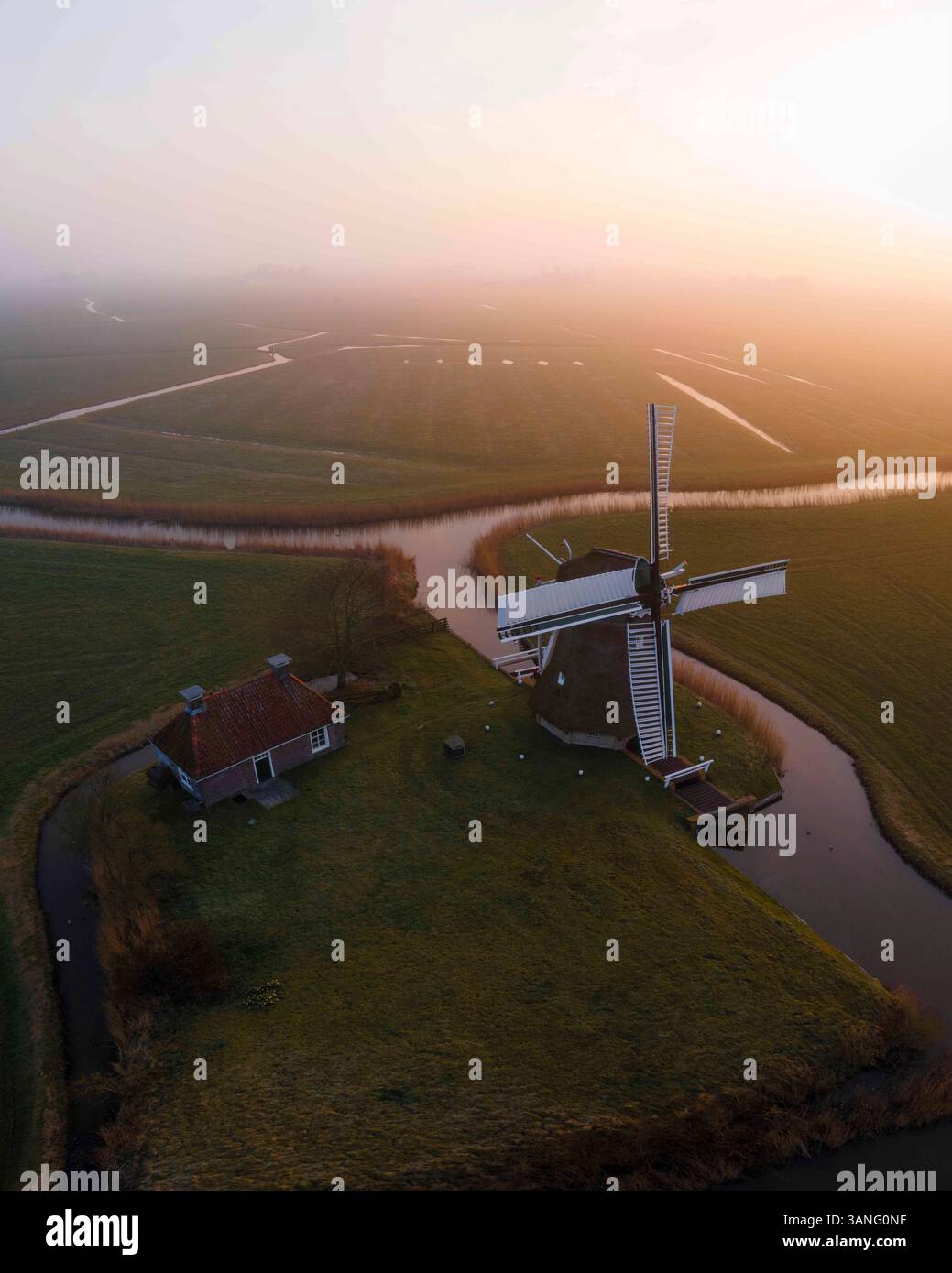 Aerial view of a charming traditional windmill and quaint house ...