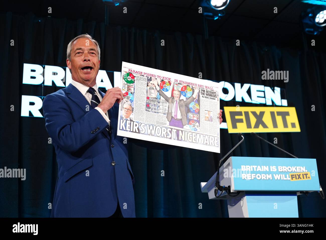Reform UK leader Nigel Farage holds up a copy of the Sun newspaper as ...