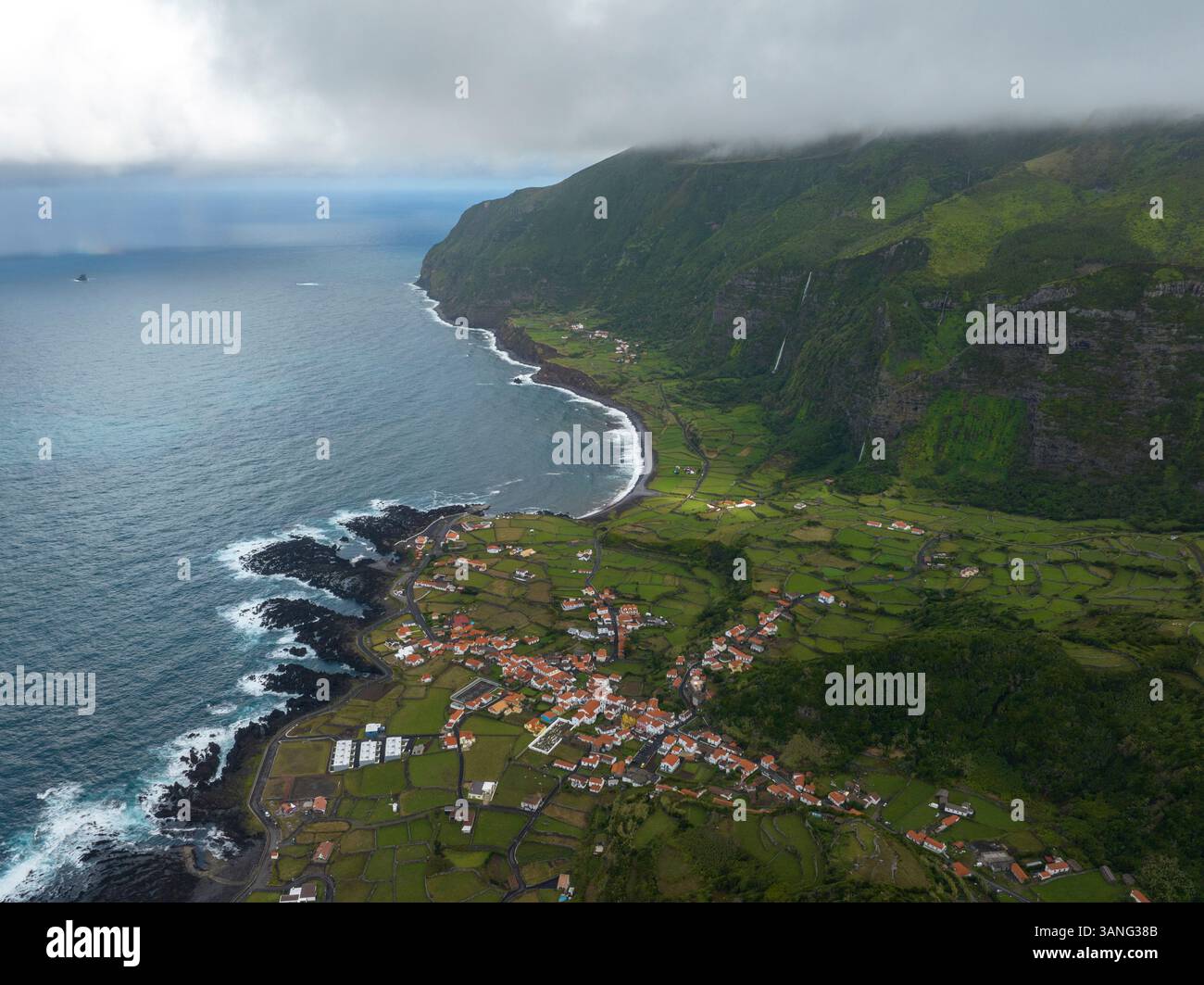 Aerial view of a picturesque village by the serene coastline with ...