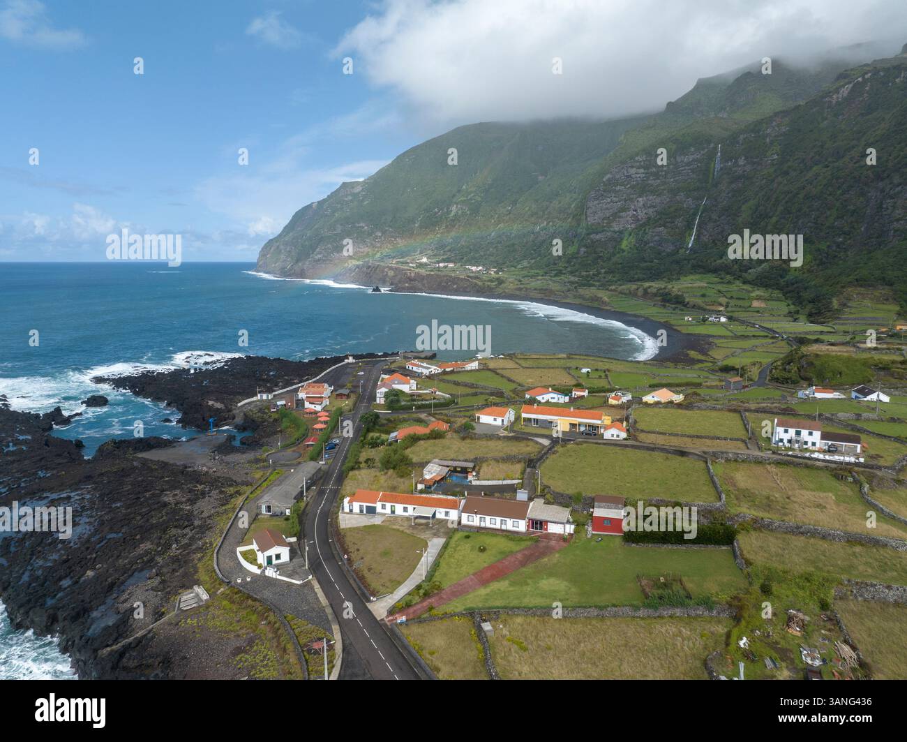 Aerial view of a picturesque village by the tranquil sea with waves ...