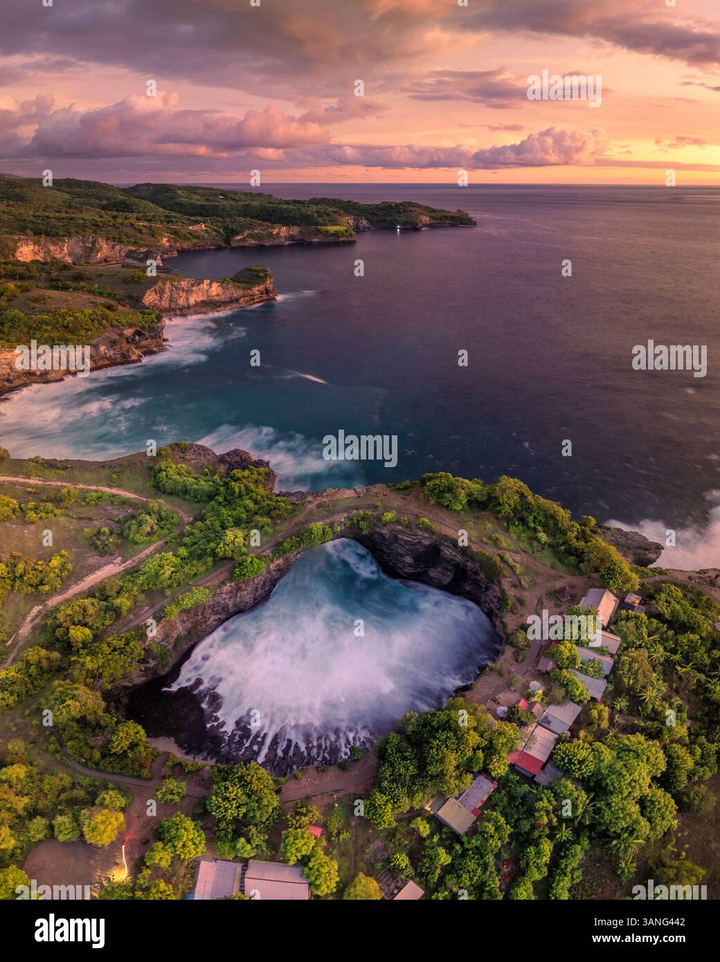 Aerial view of broken beach with clear water and dramatic cliffside ...