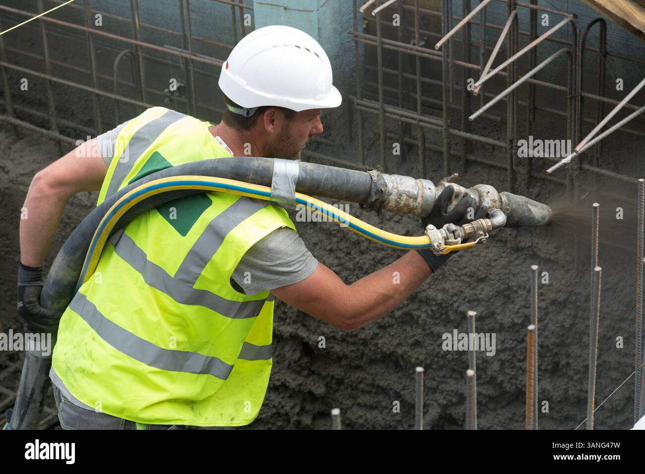 Concrete spraying in building constructiom Stock Photo - Alamy