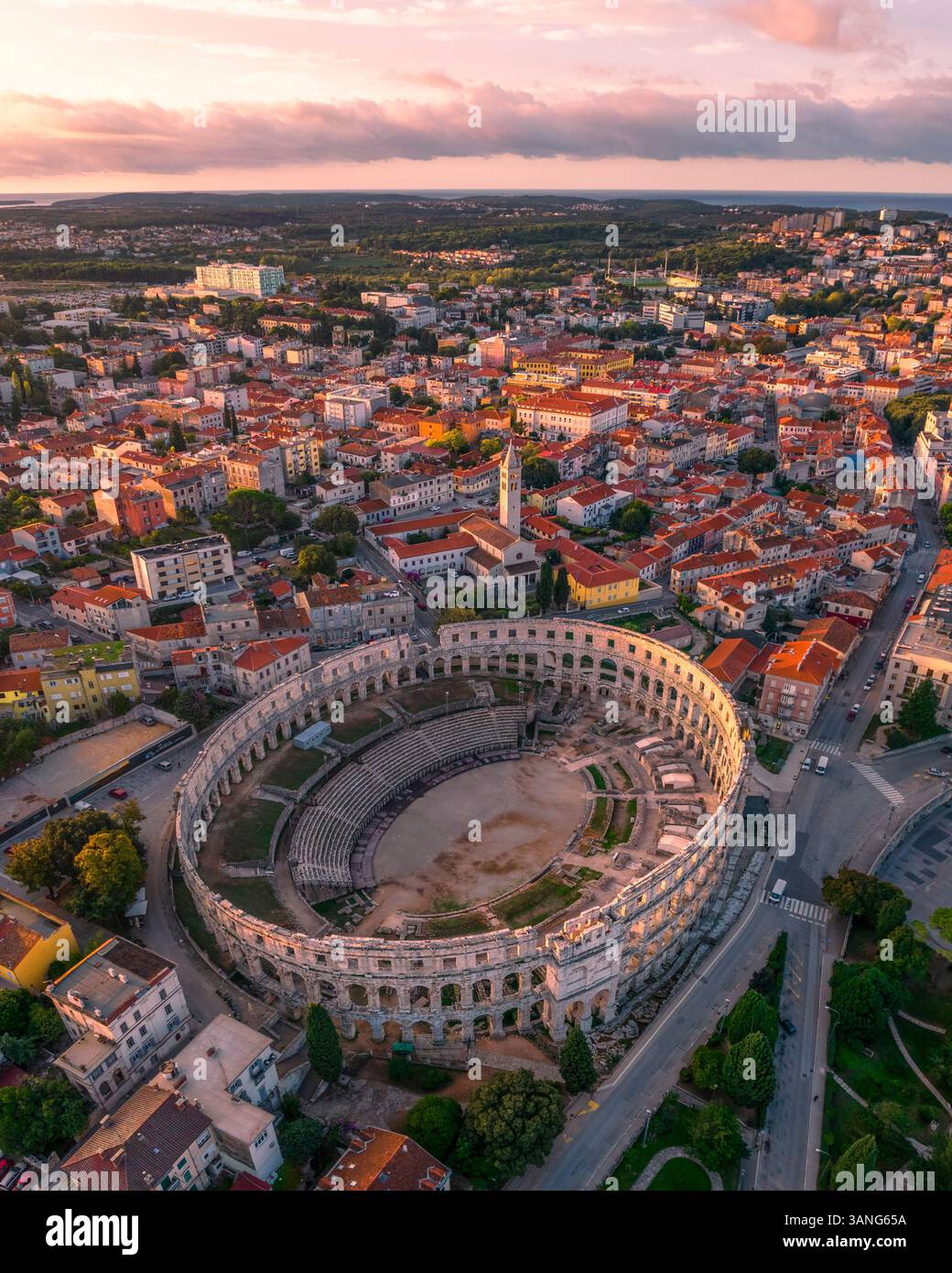 Aerial view of the ancient roman amphitheatre at sunrise surrounded by ...