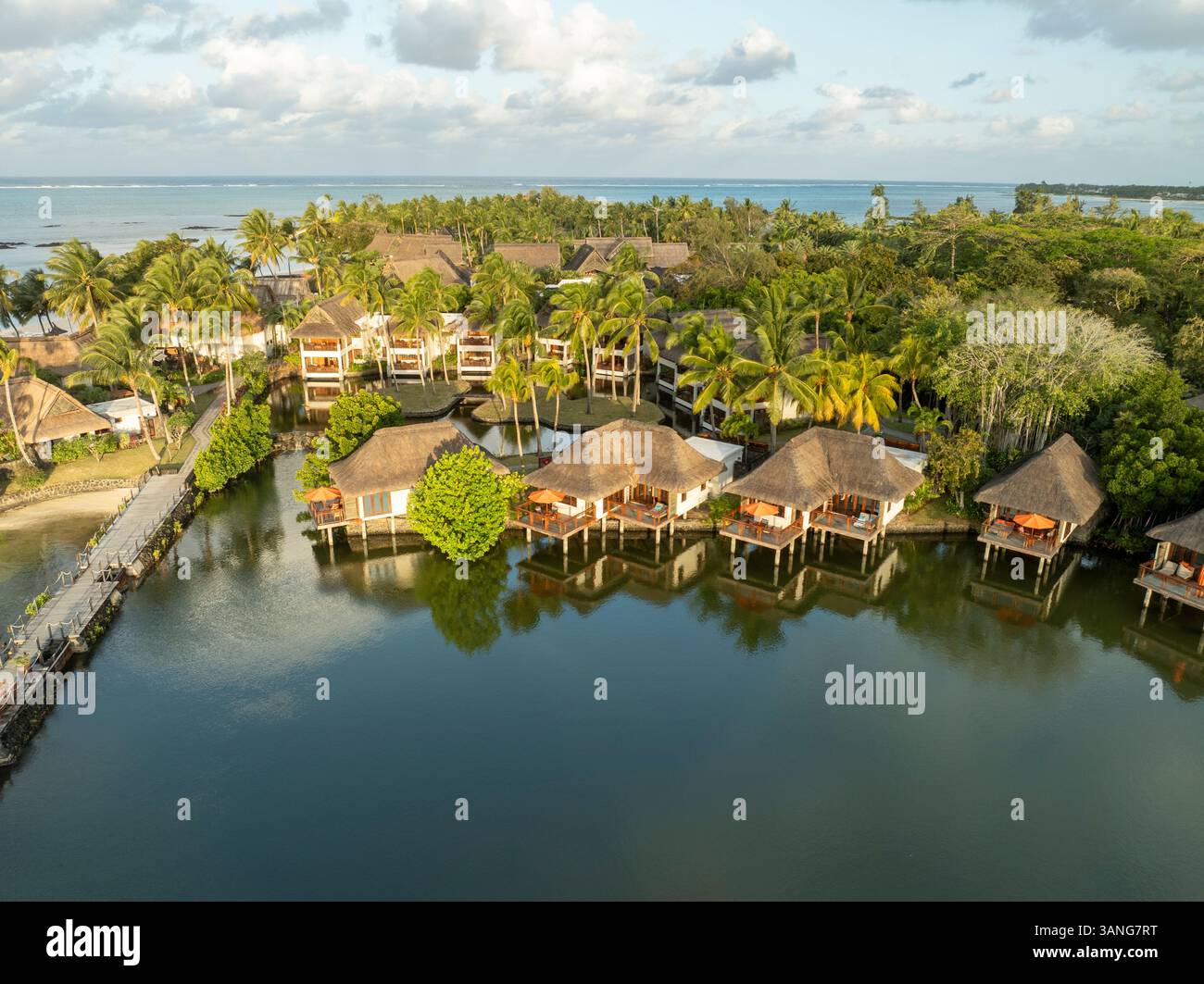 Aerial view of luxurious resort with bungalows and palm trees by the ...