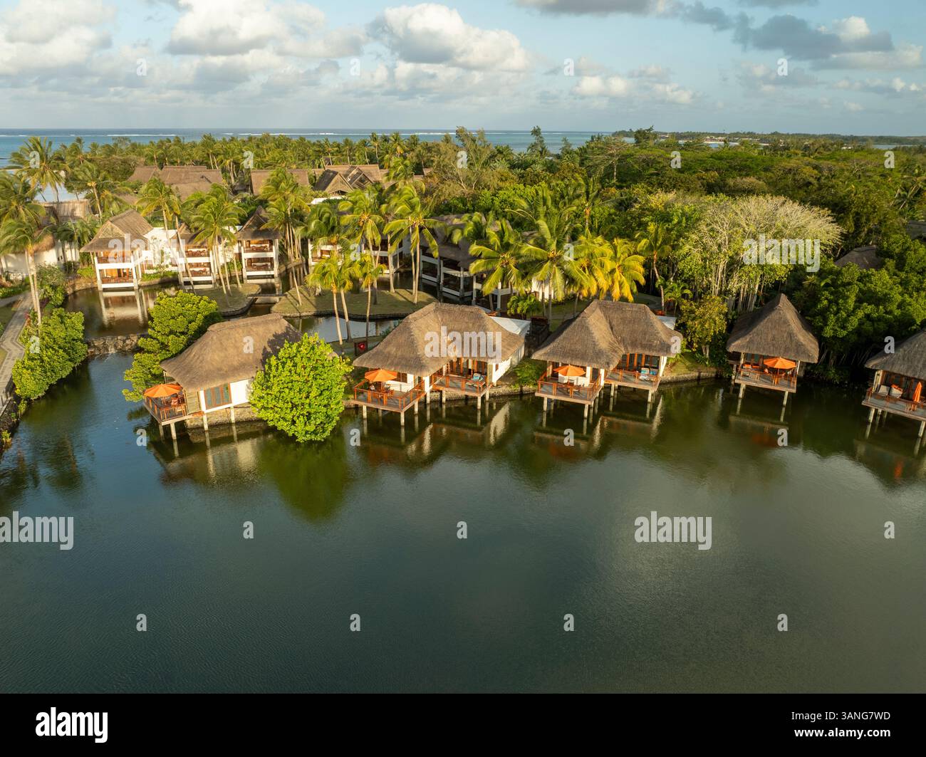 Aerial view of luxurious resort bungalows surrounded by tranquil water ...