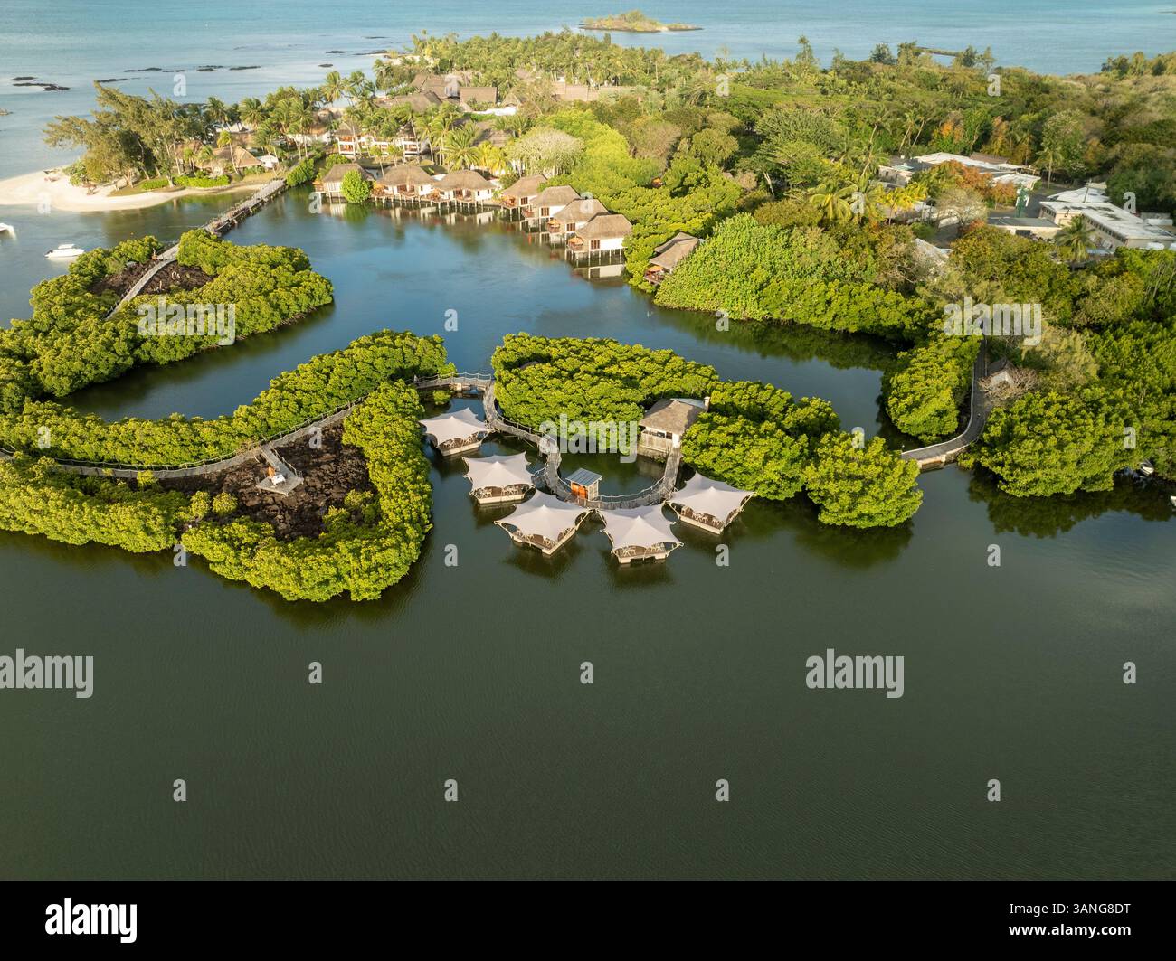 Aerial view of luxurious island resort with bungalows and serene lagoon ...