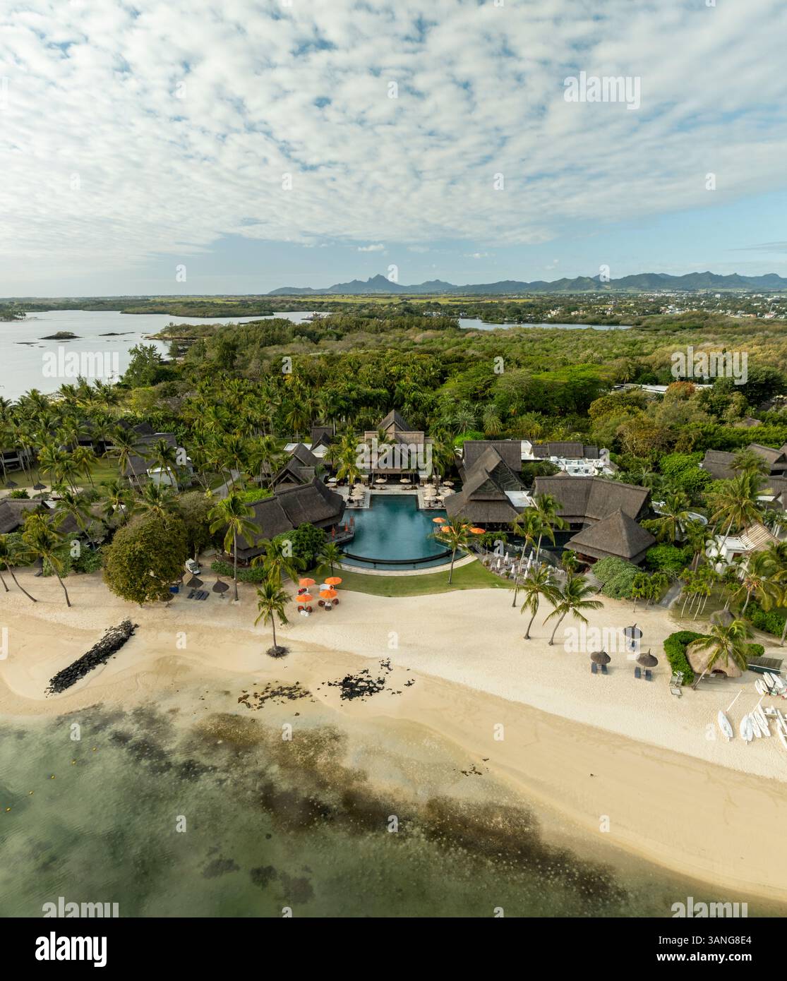 Aerial view of luxurious resort with white sand beach and palm trees ...
