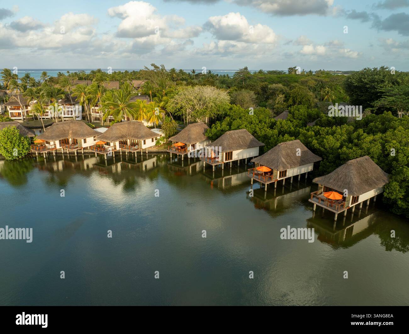 Aerial view of luxurious bungalows by the beautiful tropical water ...