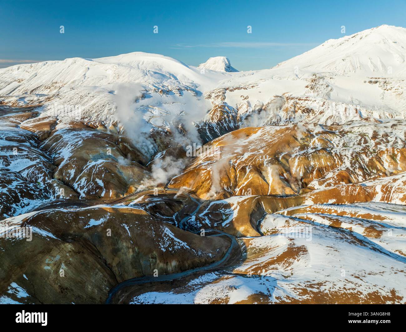 Aerial view of breathtaking snowcapped mountains and a serene valley ...