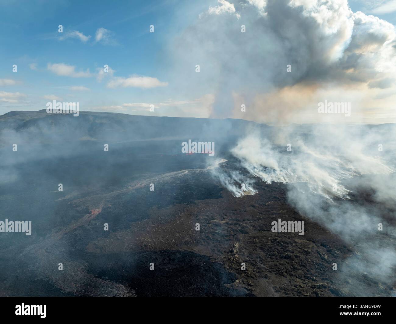 Aerial view of a majestic volcano eruption with smoke and lava amidst a ...