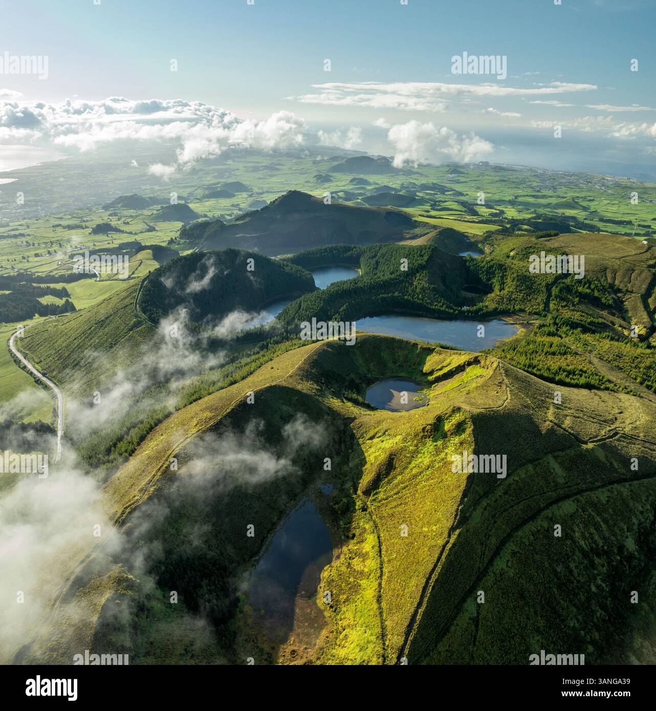 Aerial view of Seven Lakes surrounded by green hills and rugged terrain ...
