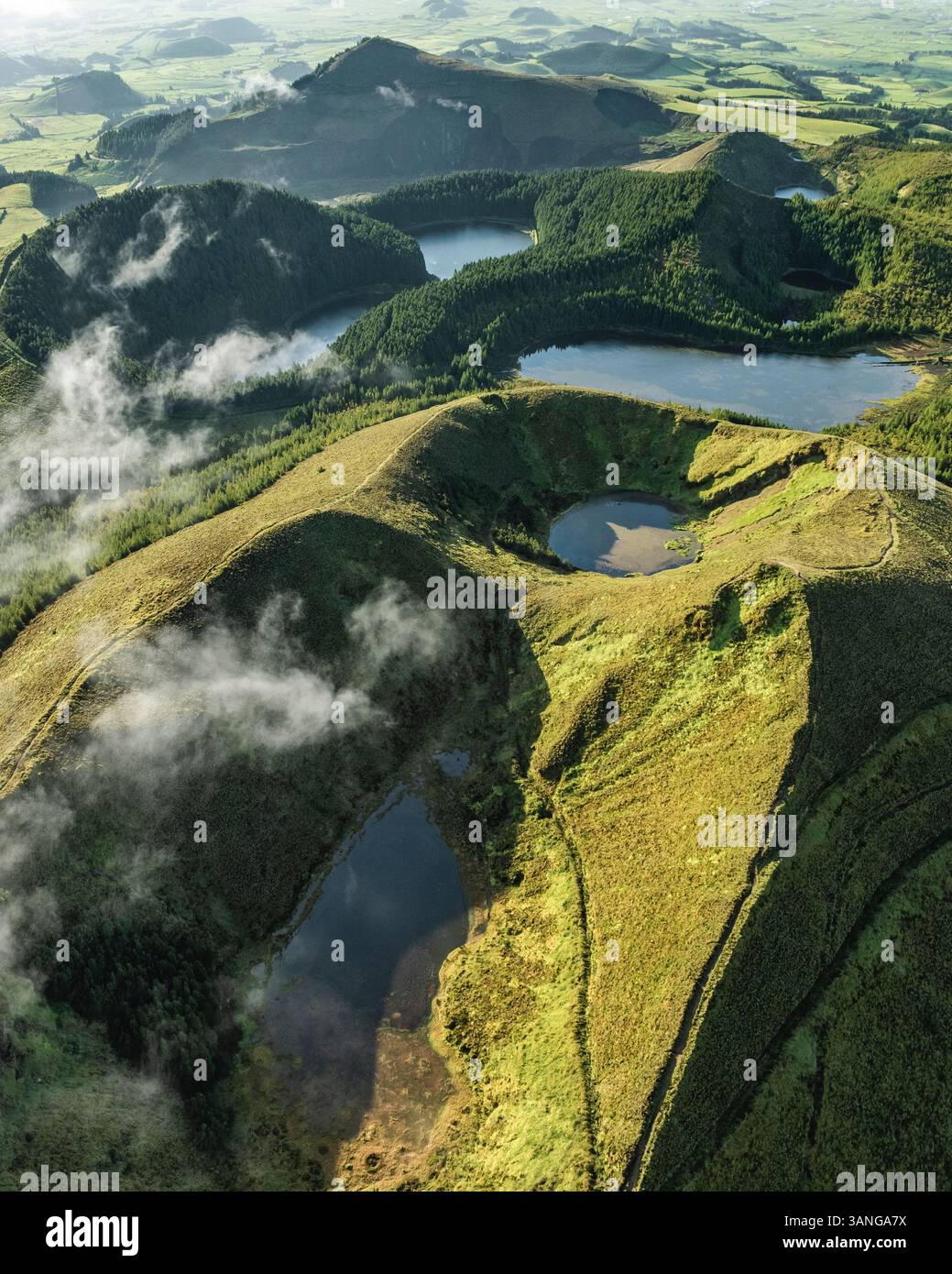 Aerial view of Seven Lakes surrounded by mountains, clouds, and lush ...