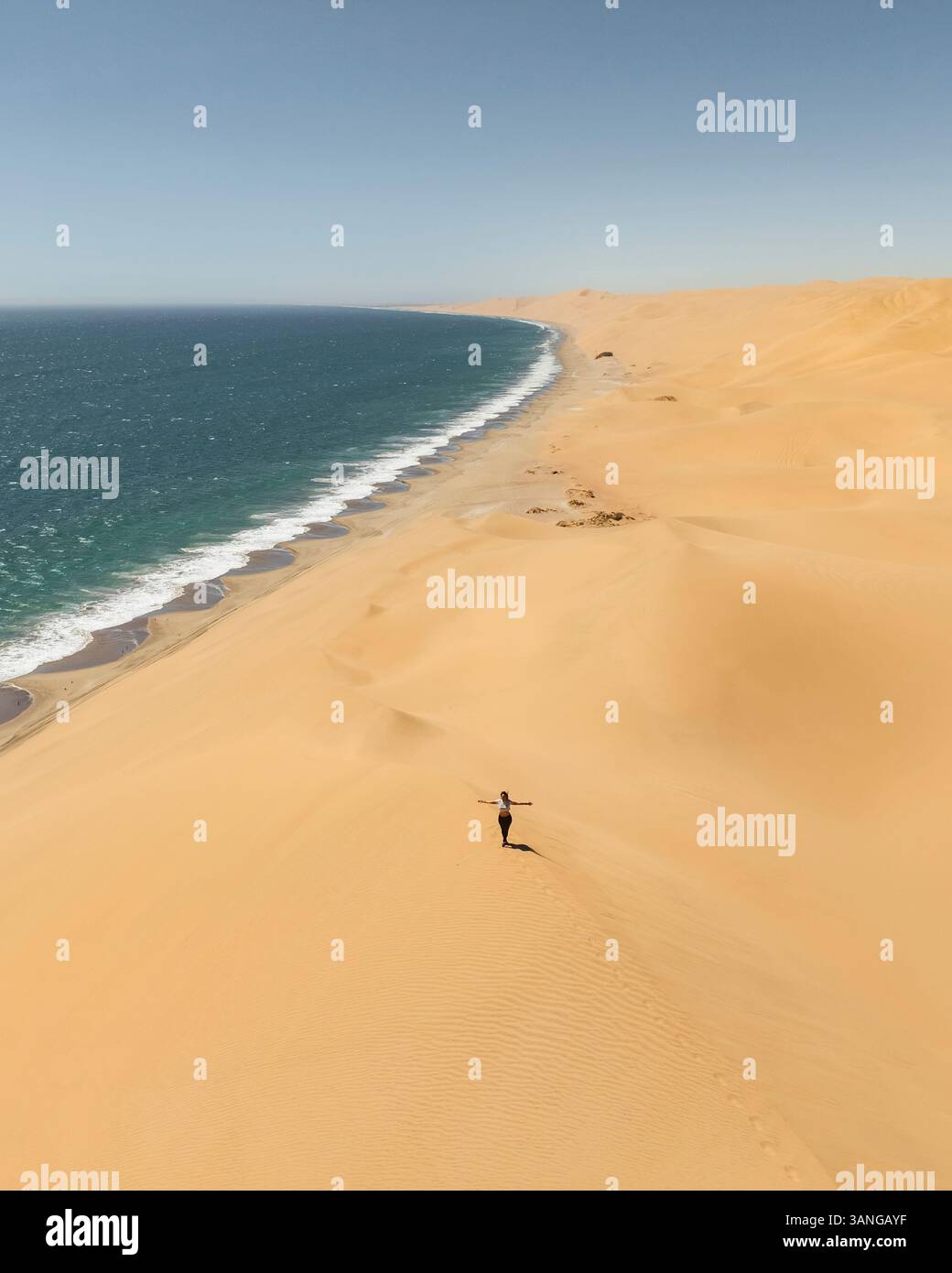 Aerial view of sand dune patterns meeting the ocean at Sandwich Harbour ...