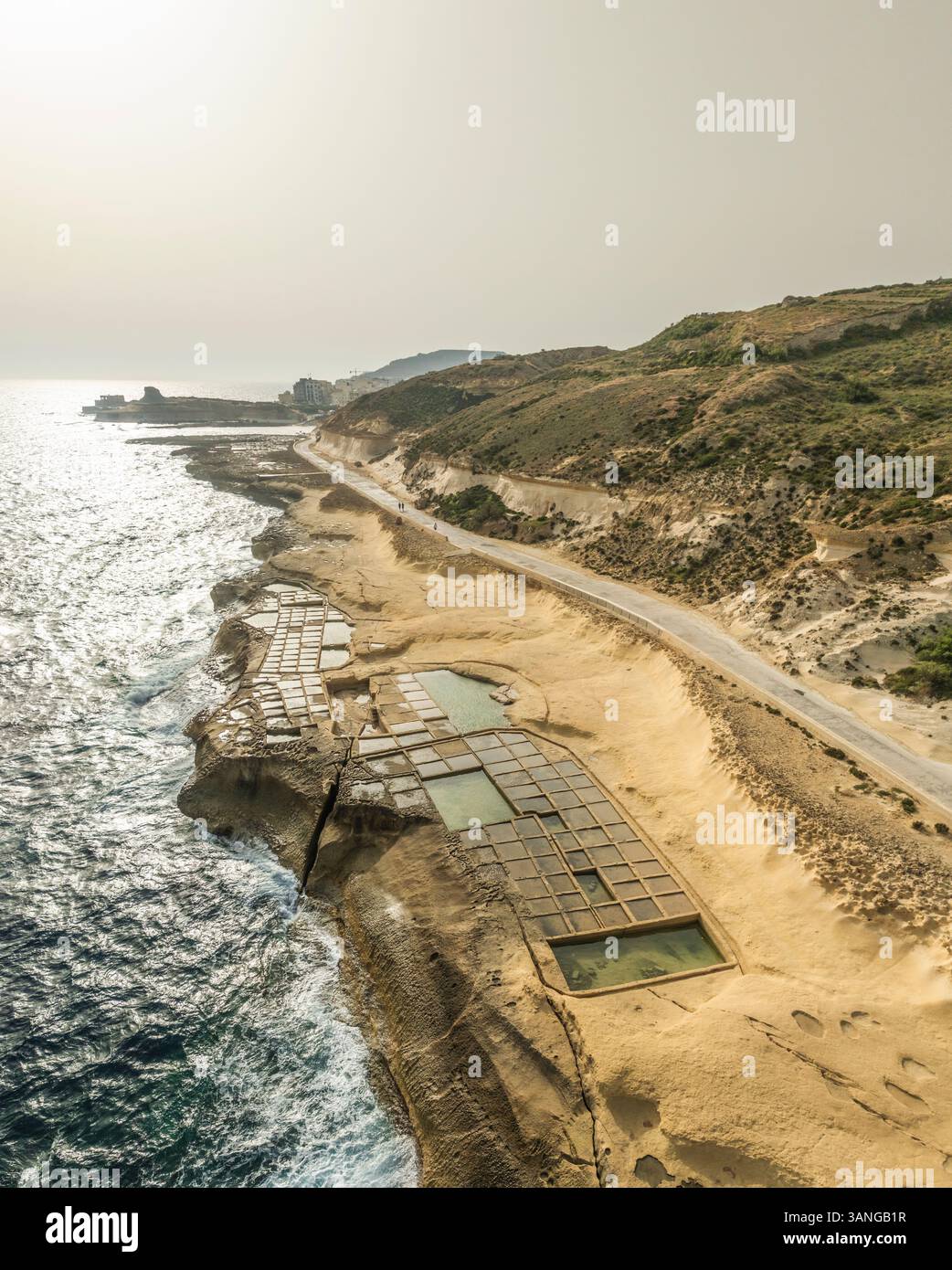 Aerial view of salt pans and coastline along rocky coast, Zebbug Gozo ...