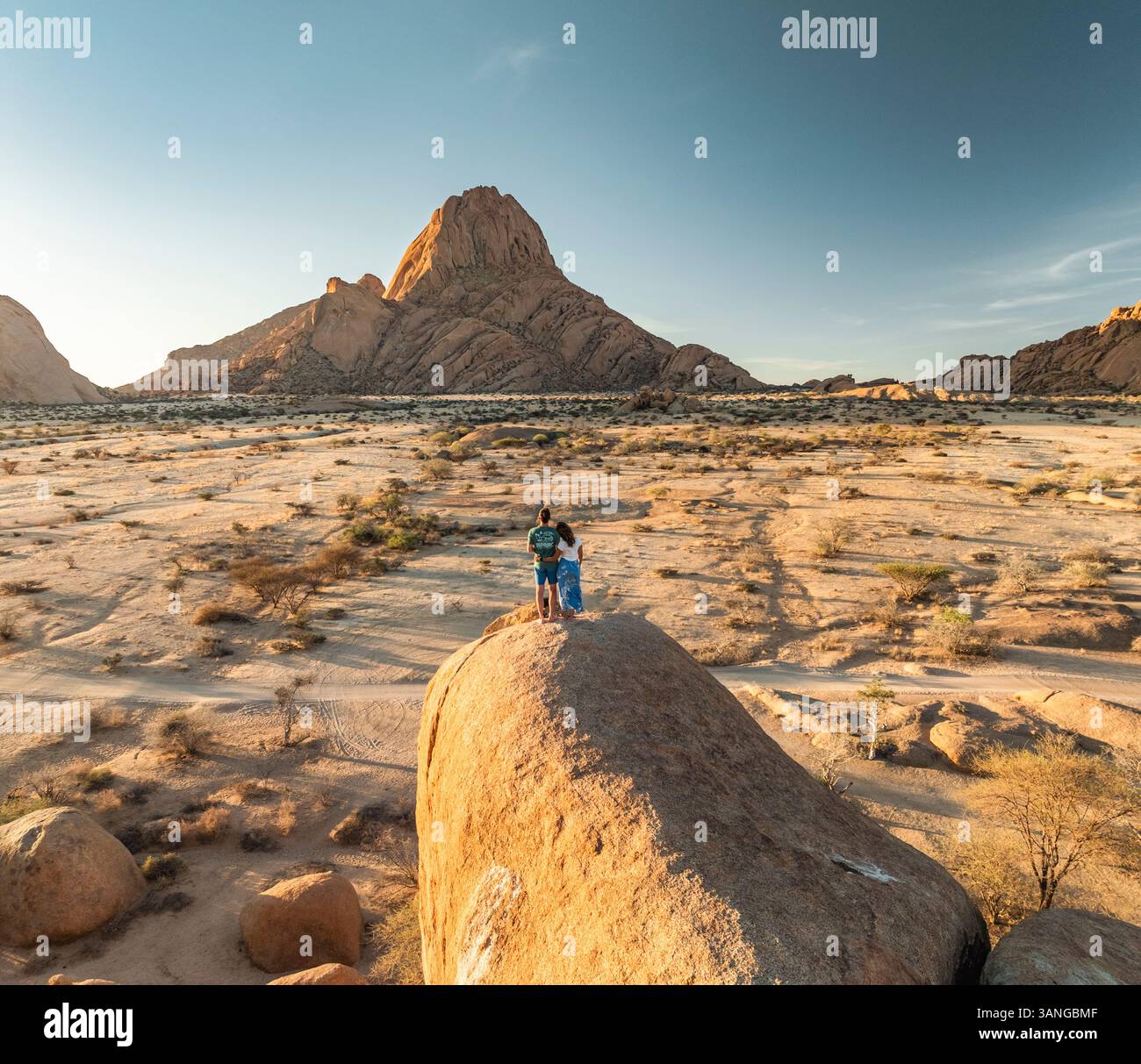 Aerial view of majestic Spitzkoppe Peak with couple, Namib Desert ...
