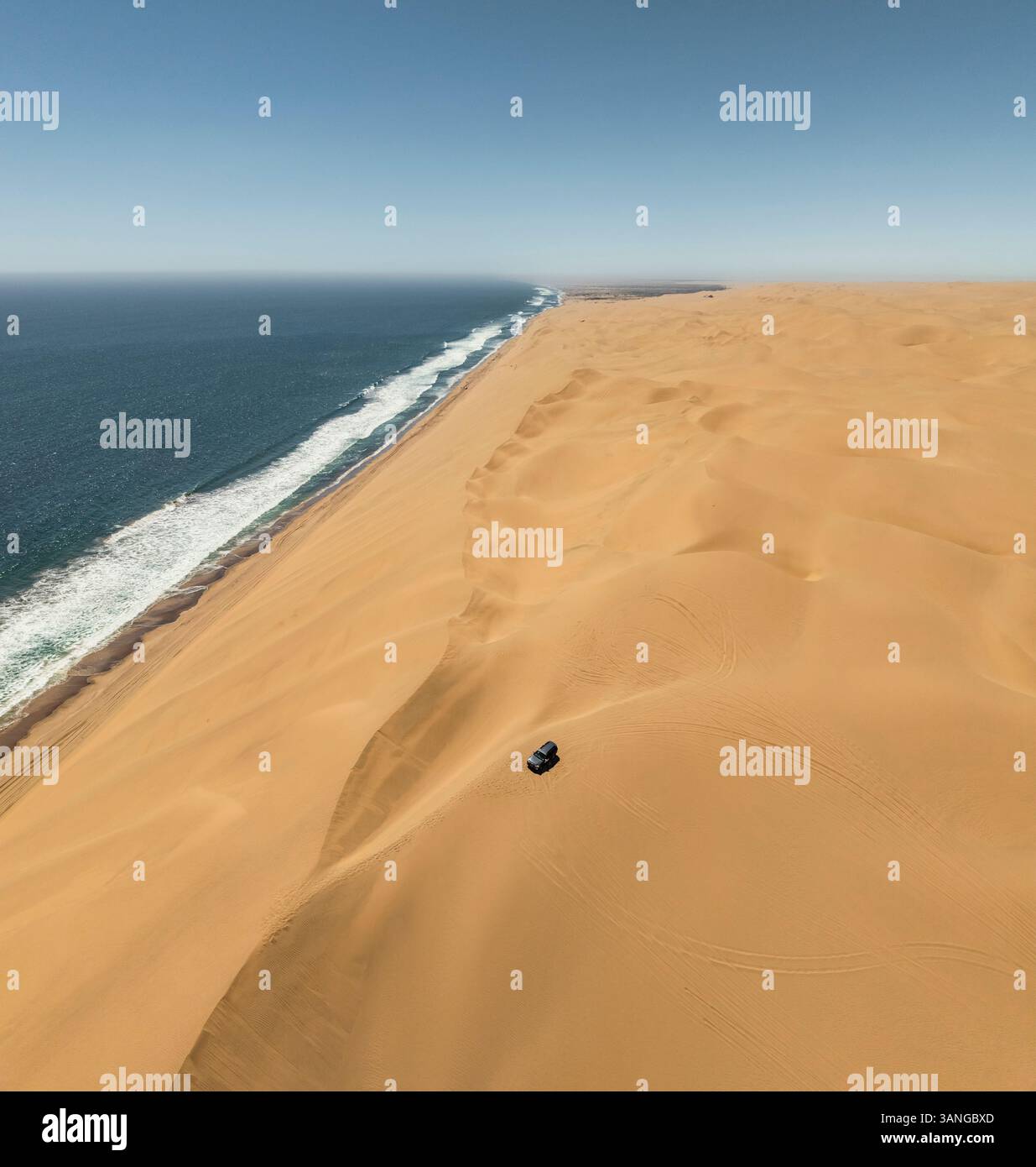 Aerial view of sand dune patterns meeting the ocean at Sandwich Harbour ...