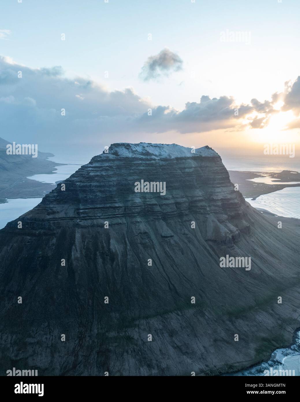 Aerial view of Kirkjufell mountain and Kirkjufellsfossar at dawn ...