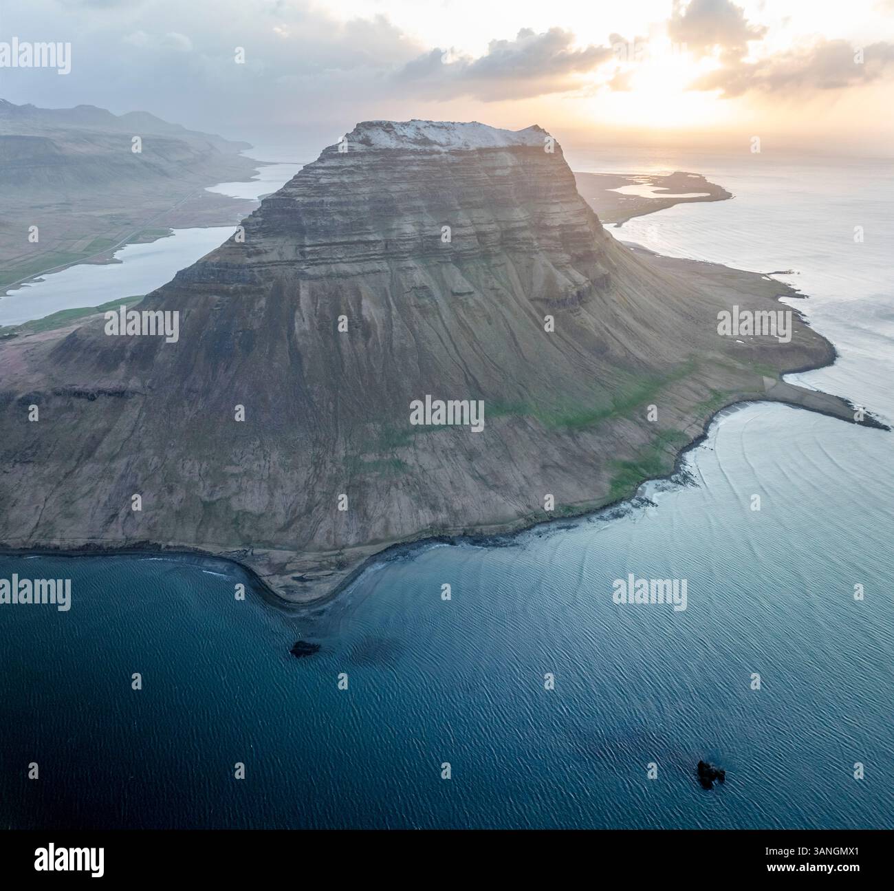 Aerial view of Kirkjufell mountain and Kirkjufellsfossar in sunset ...