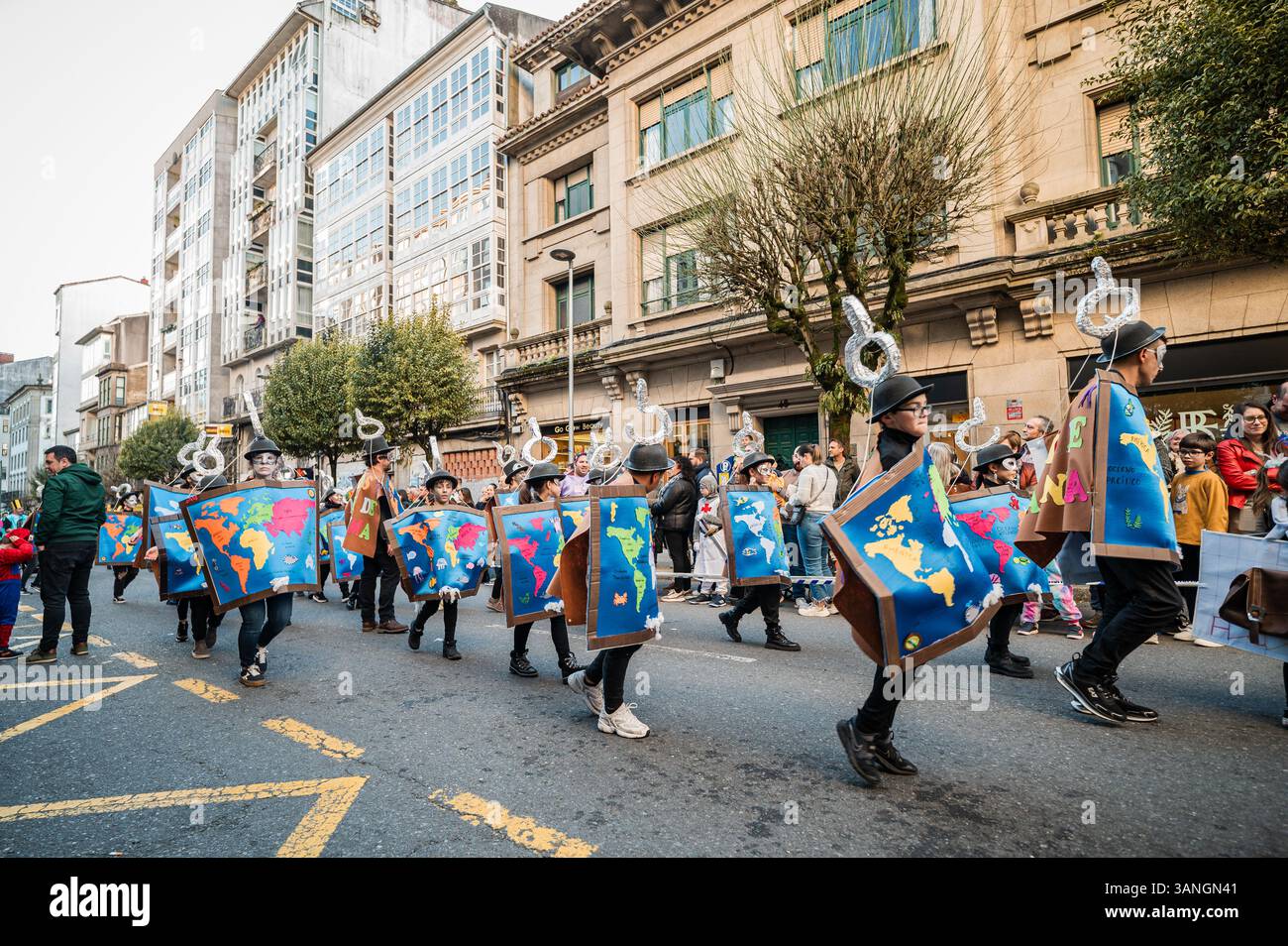 School students marching in carnival parade with world map costumes in ...