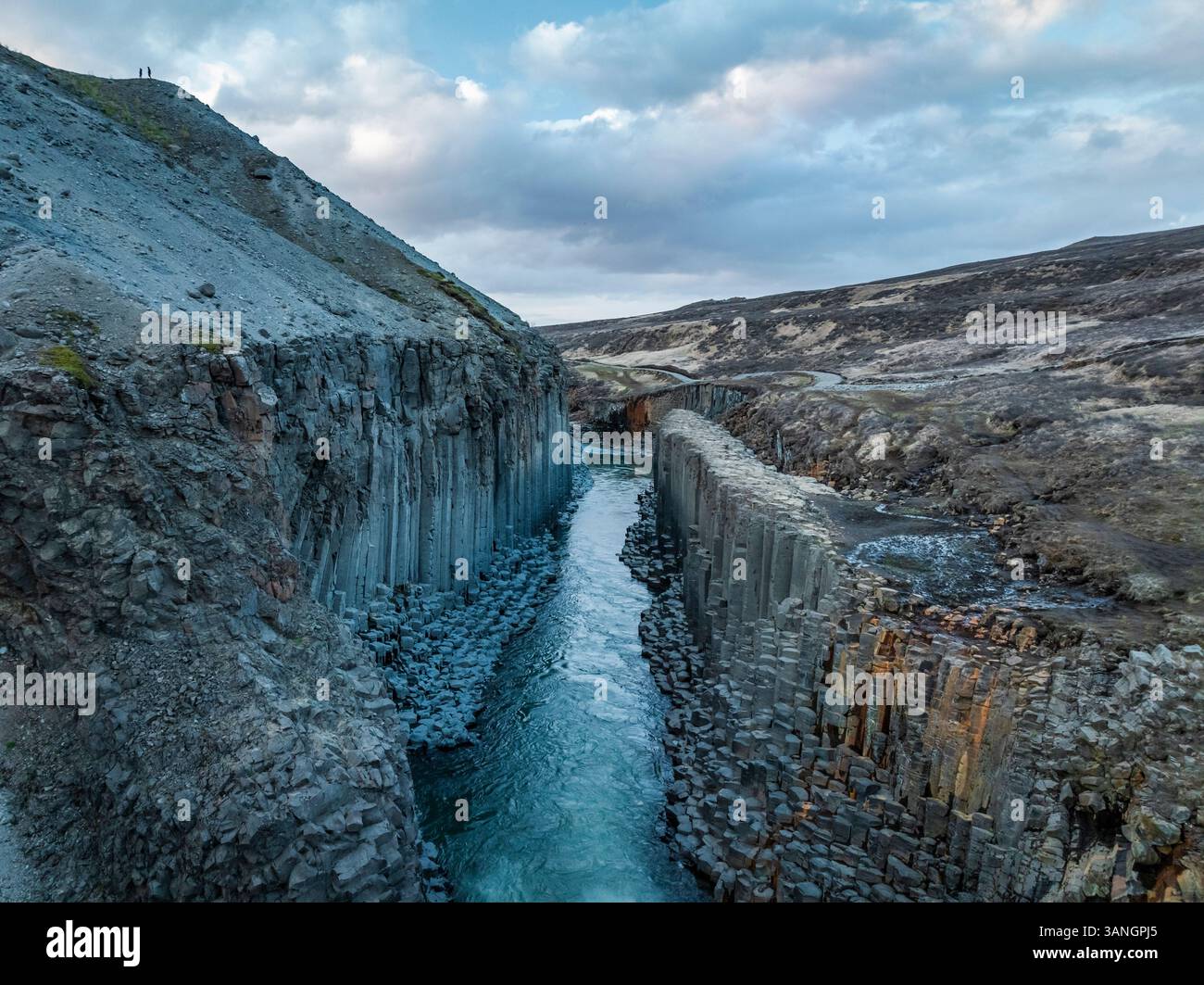 Aerial view of Studlagil canyon and river with basalt columns, Eastern ...