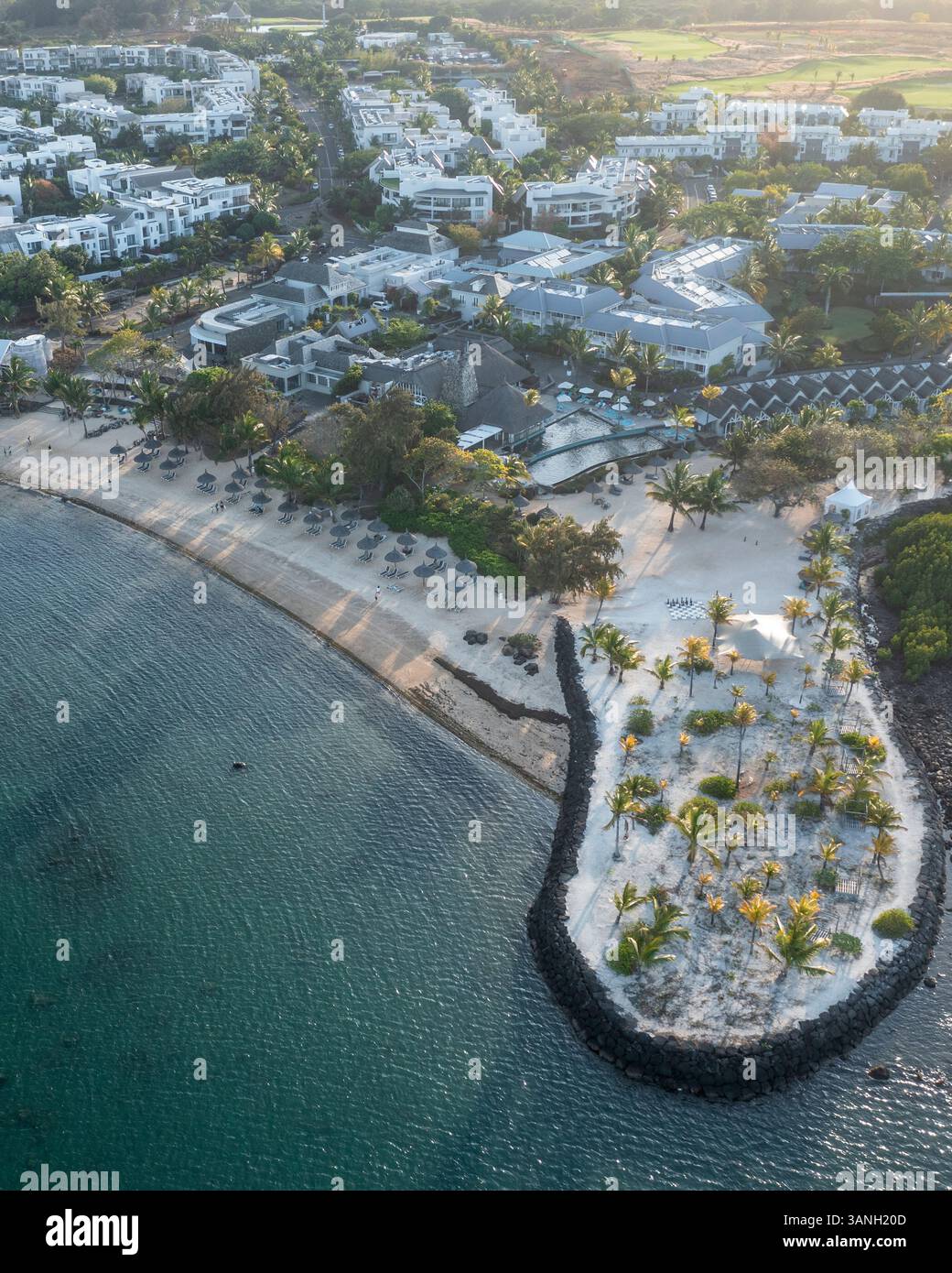 Aerial view of a luxury resort along the coastline with private beach ...