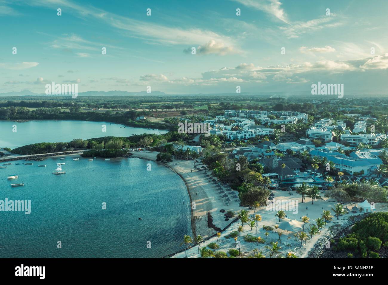 Aerial view of a luxury resort along the coastline with private beach ...