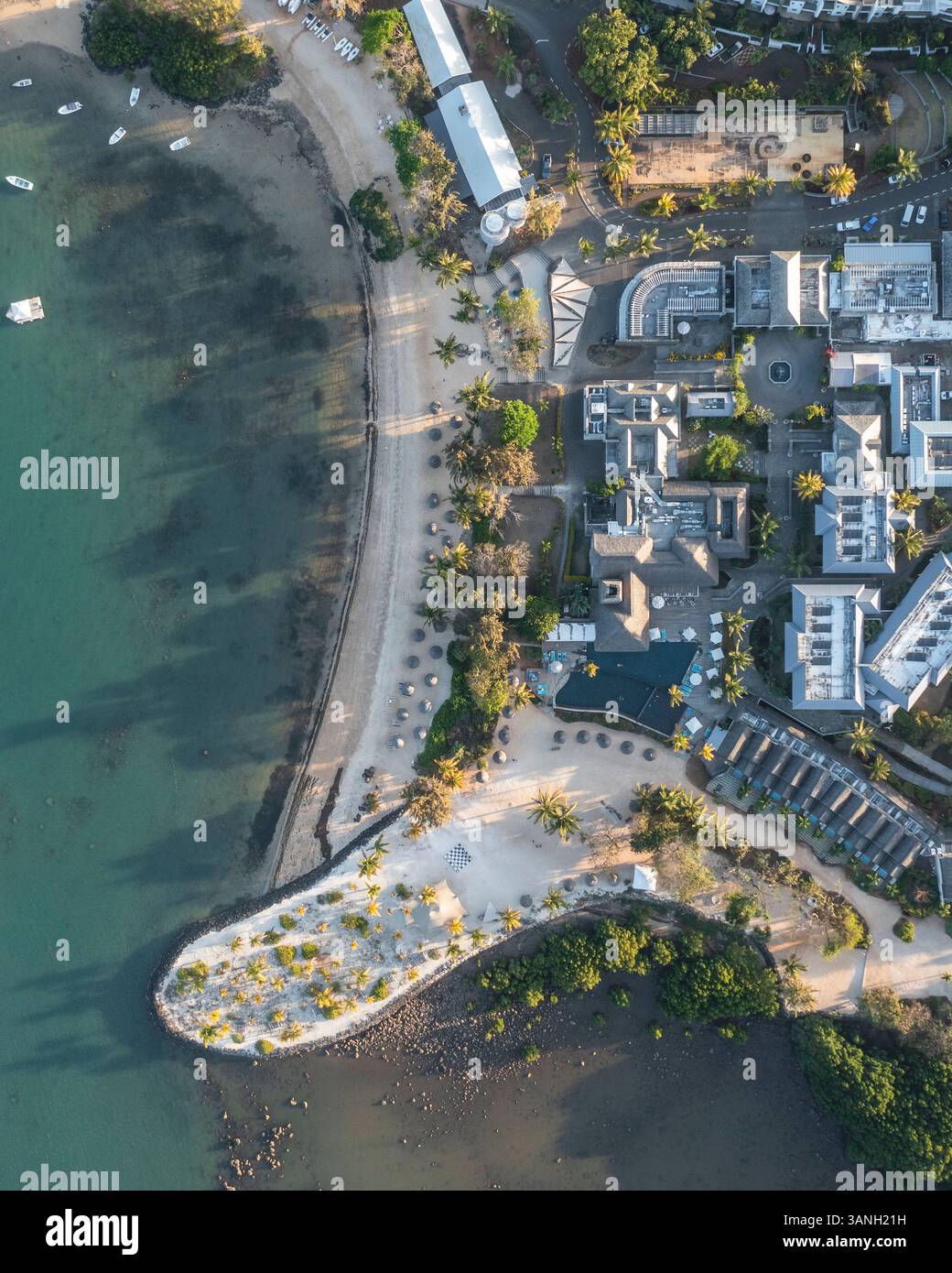 Aerial view of a luxury resort along the coastline with boats in the ...