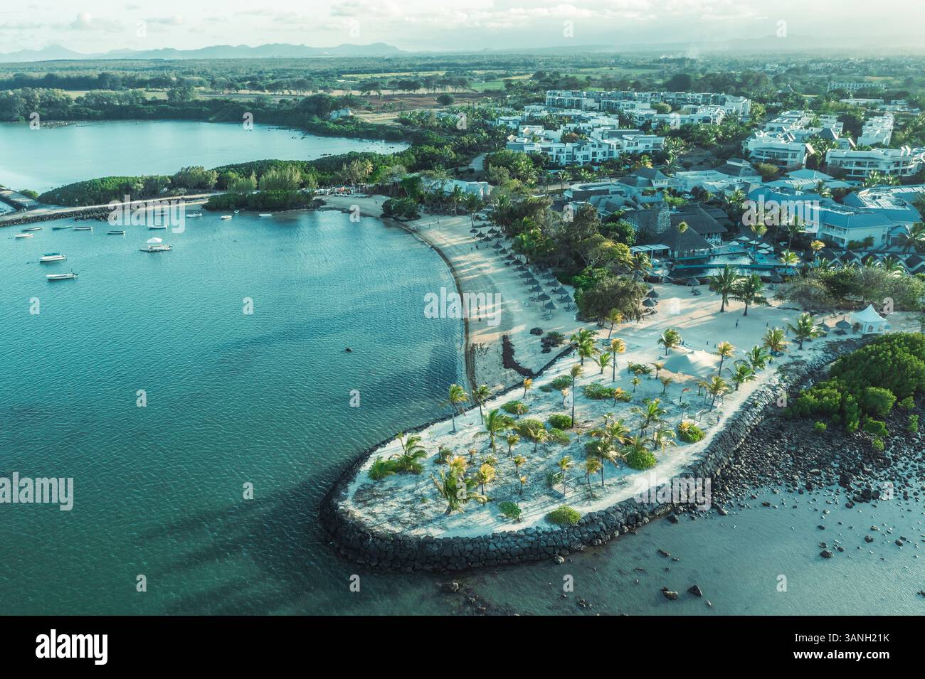 Aerial view of a luxury resort along the coastline with private beach ...