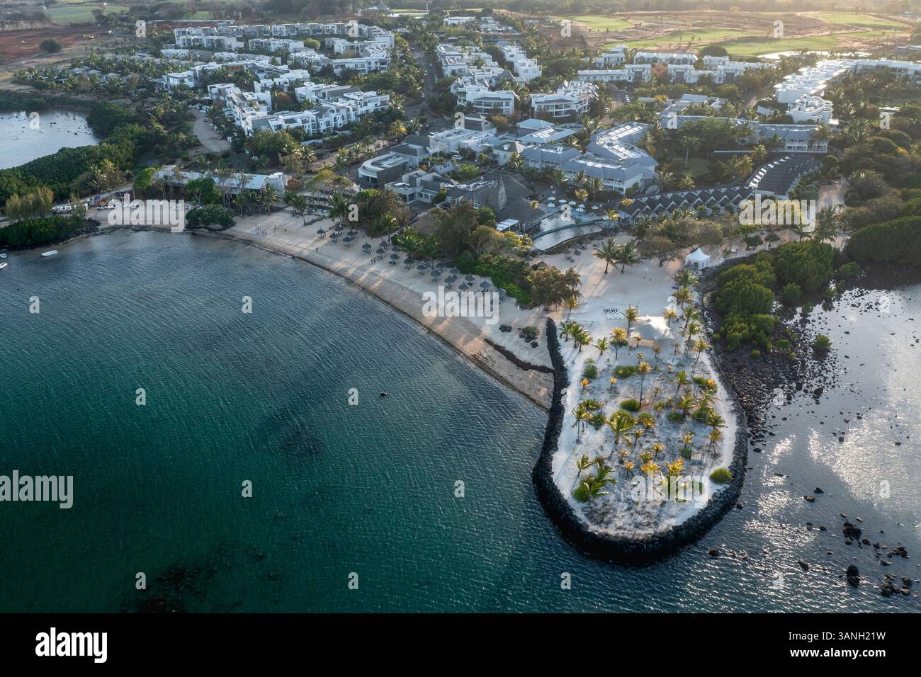 Aerial view of a luxury resort along the coastline with private beach ...