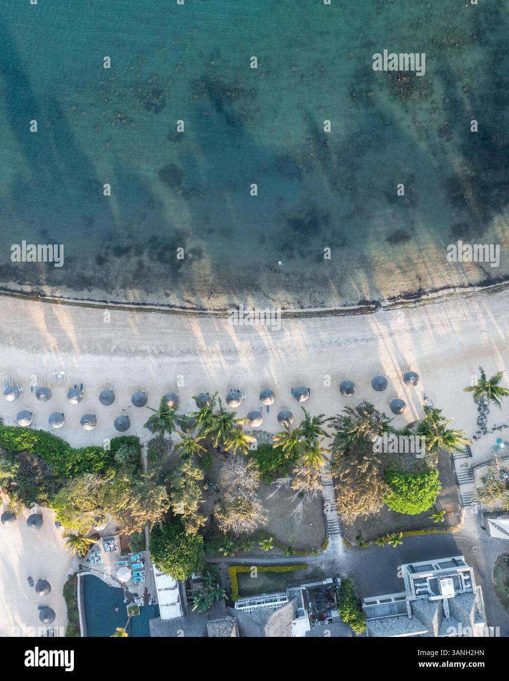 Aerial view of a luxury resort along the coastline with private beach ...