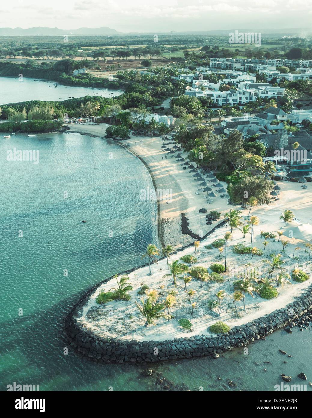 Aerial view of a luxury resort along the coastline with private beach ...