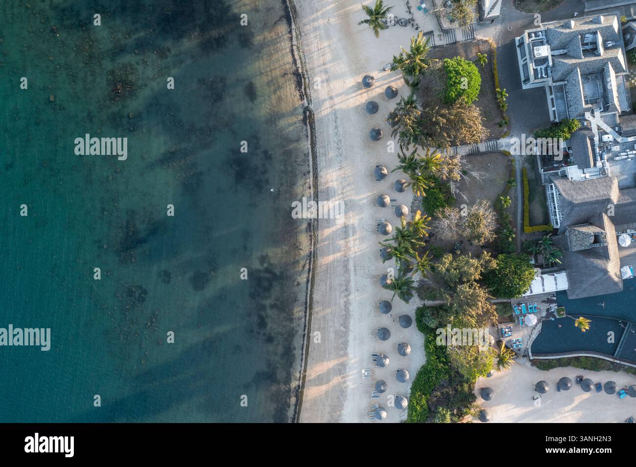 Aerial view of a luxury resort along the coastline with private beach ...