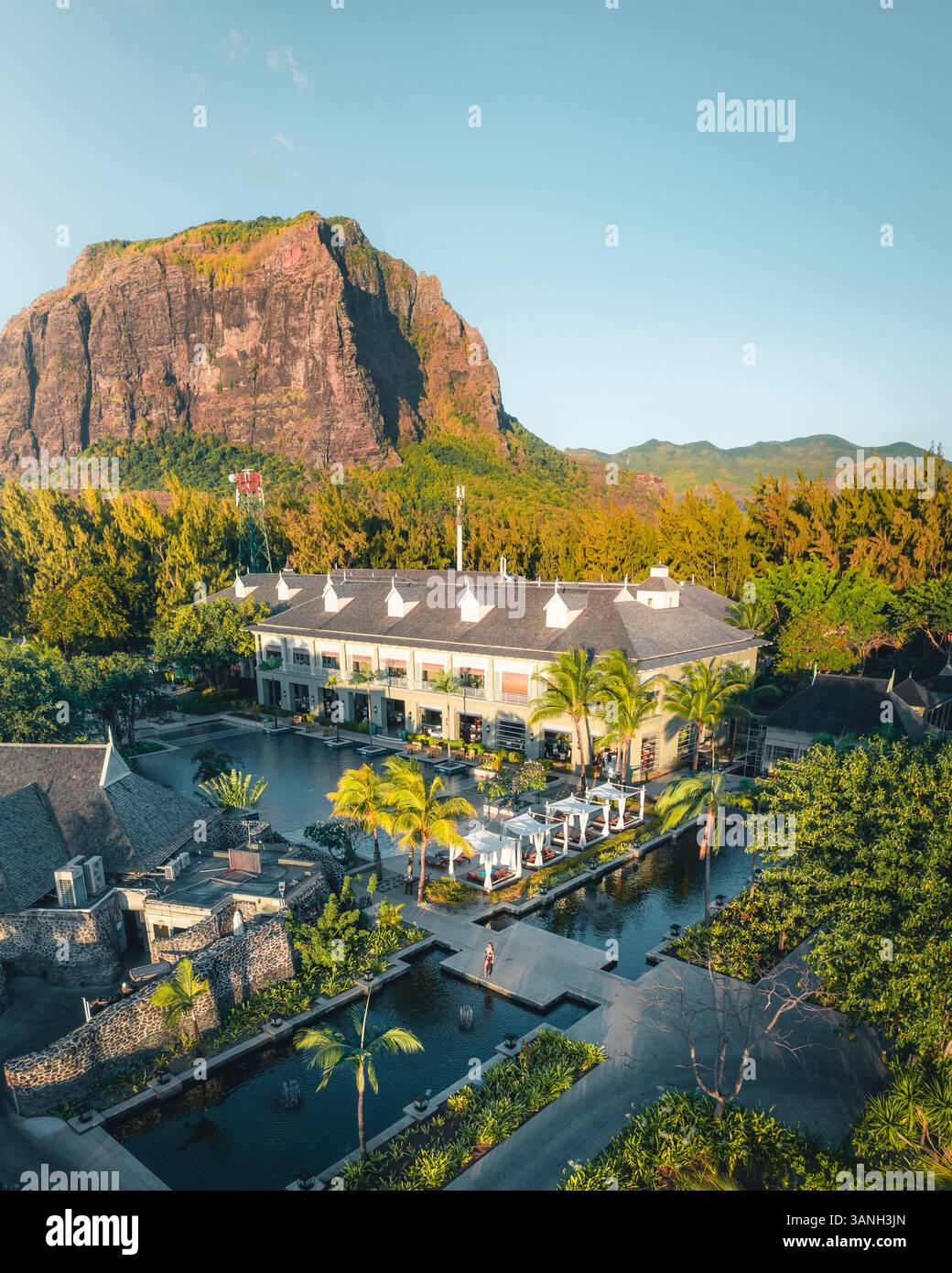 Aerial view of a woman along the swimming pool of luxury resort ...