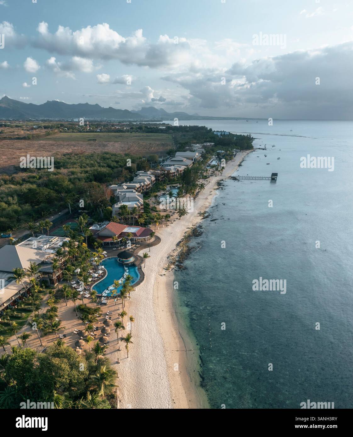 Aerial view of hotels and resorts on the beachfront along the coastline ...