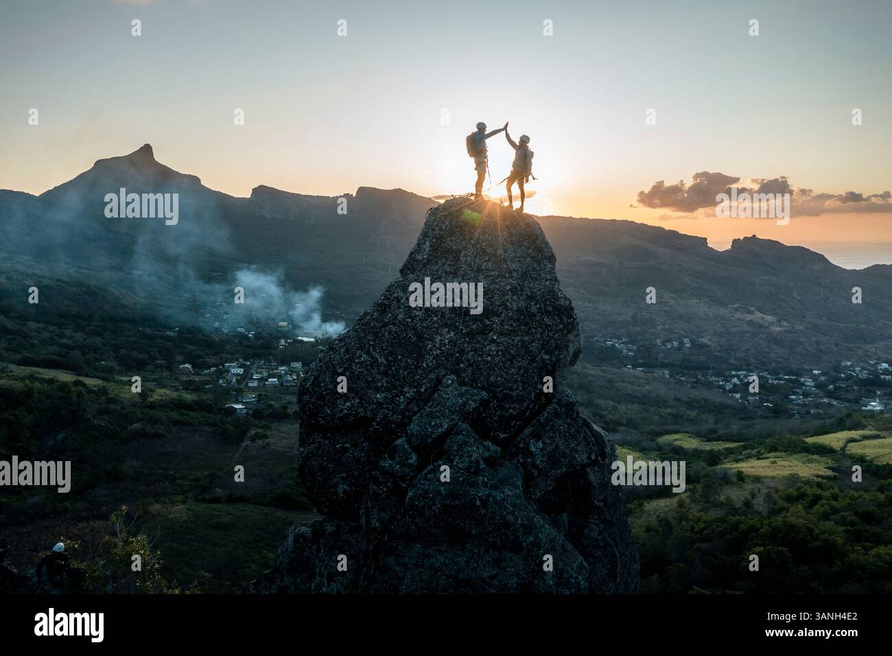 Aerial view of people climbing on Piton Jacob Peak mountain in Port ...