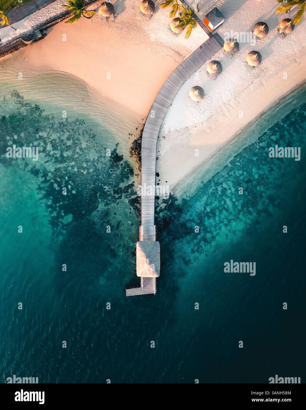 Aerial view of a walking pier on the beach along the coast in Poste de ...
