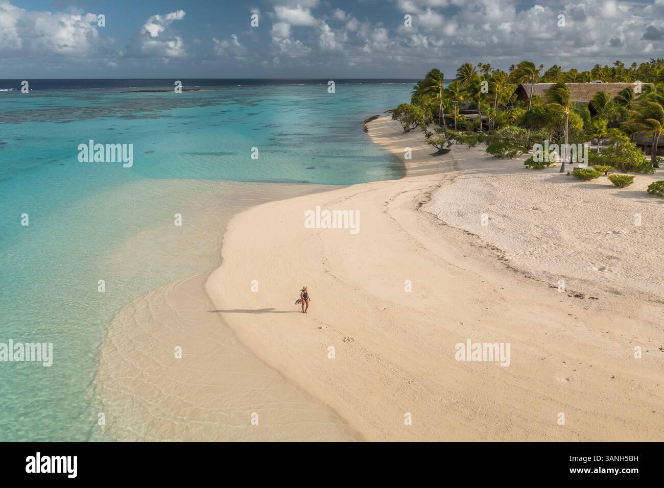 Aerial view of a person walking along the shore on the beach on Onetahi ...