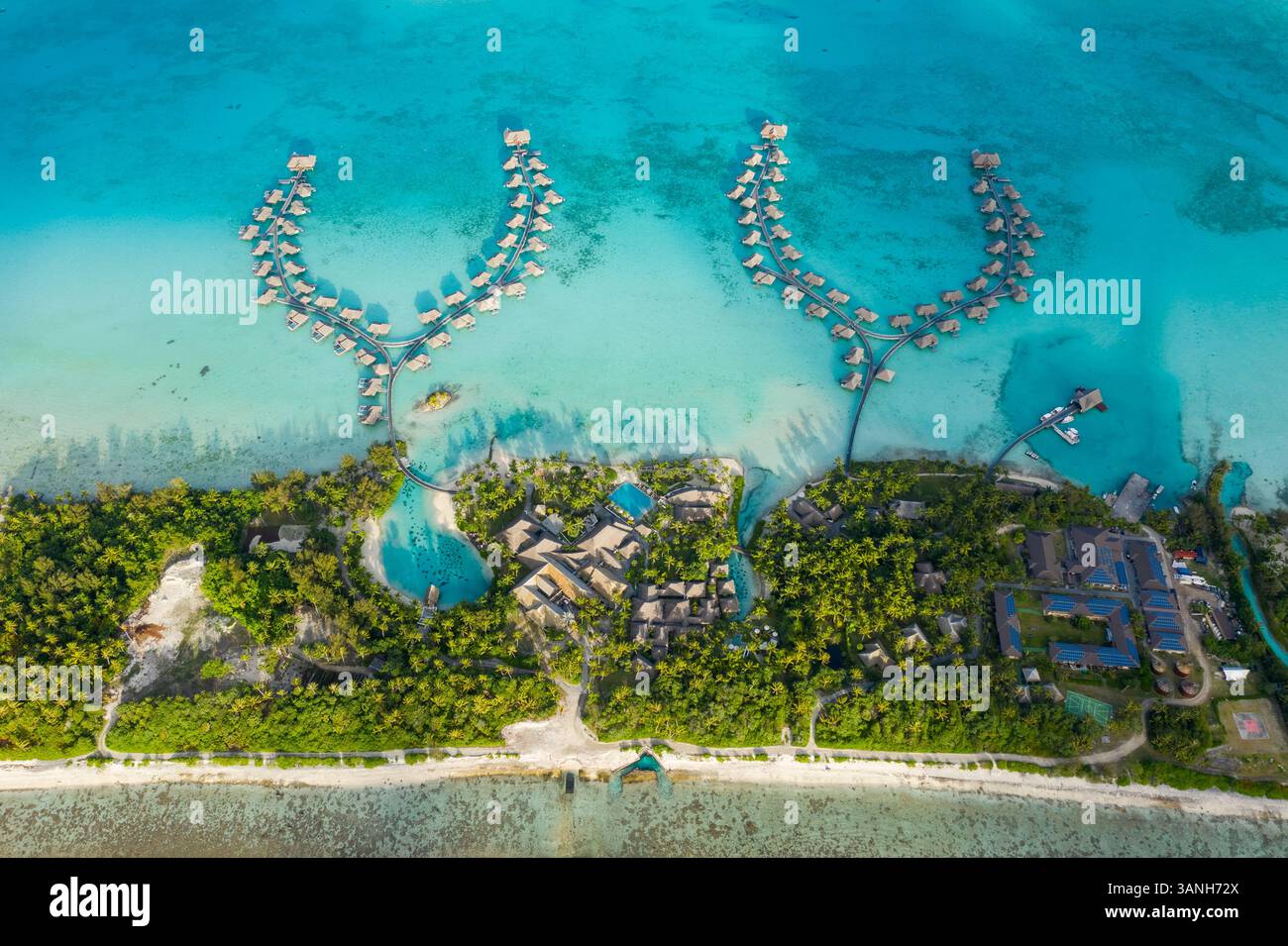 Aerial view of wooden huts from a luxury hotel along the reef in Tahiti ...