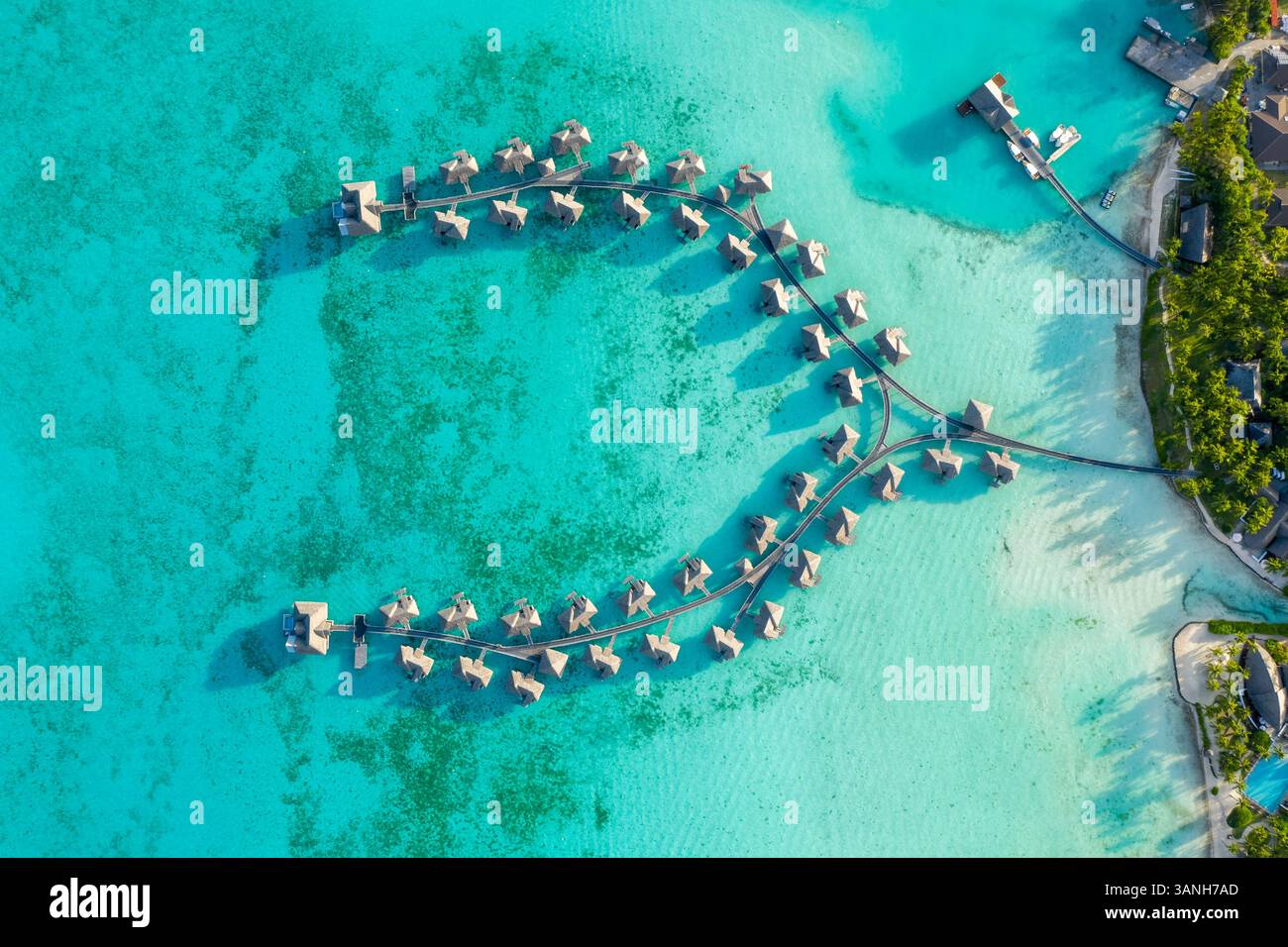 Aerial view of wooden huts from a luxury hotel along the reef in Tahiti ...
