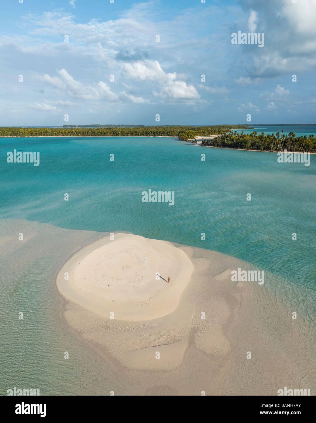 Aerial view of a person walking on white sand on Onetahi island, French ...