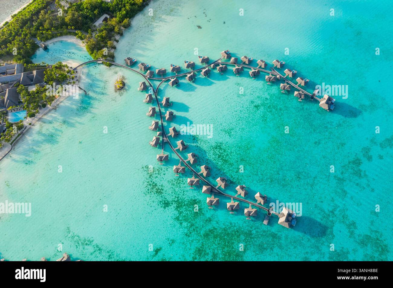 Aerial view of wooden huts from a luxury hotel along the reef in Tahiti ...