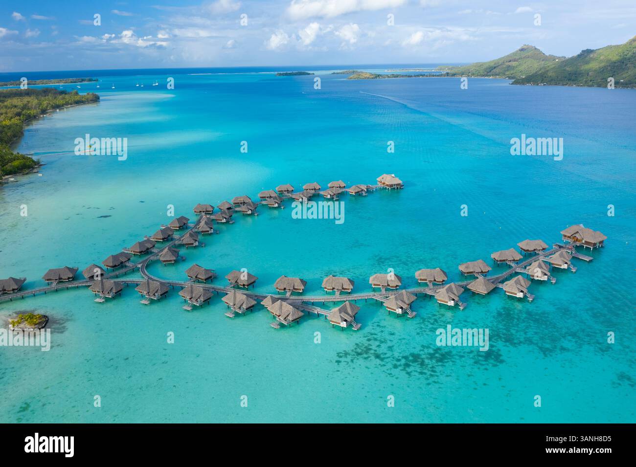 Aerial view of wooden huts from a luxury hotel along the reef in Tahiti ...
