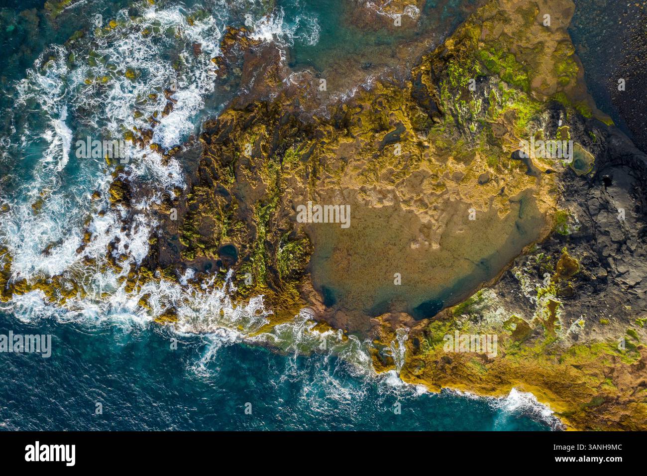 Aerial View of Piscinas Naturais Caneiros rock pool, on the cliff along ...