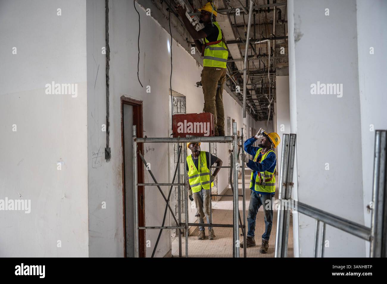 Libreville. 14th Apr, 2025. Workers renovate the electric circuits in ...