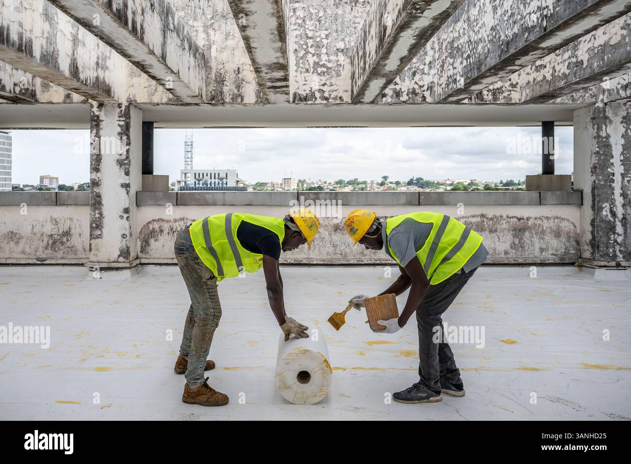 Libreville. 14th Apr, 2025. Workers renovate the waterproof layer in ...