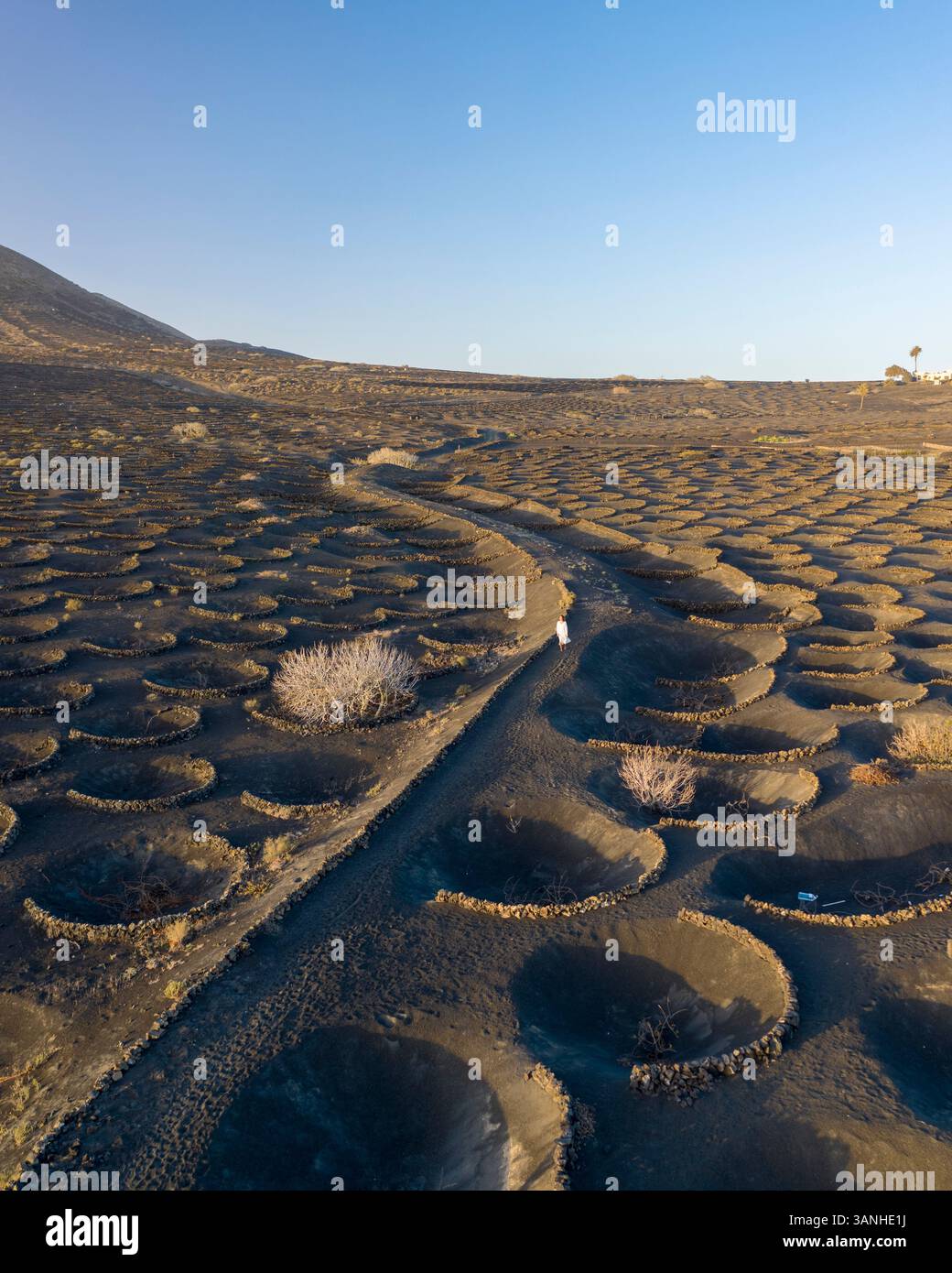 Aerial view of a woman walking among volcano holes formation at ...