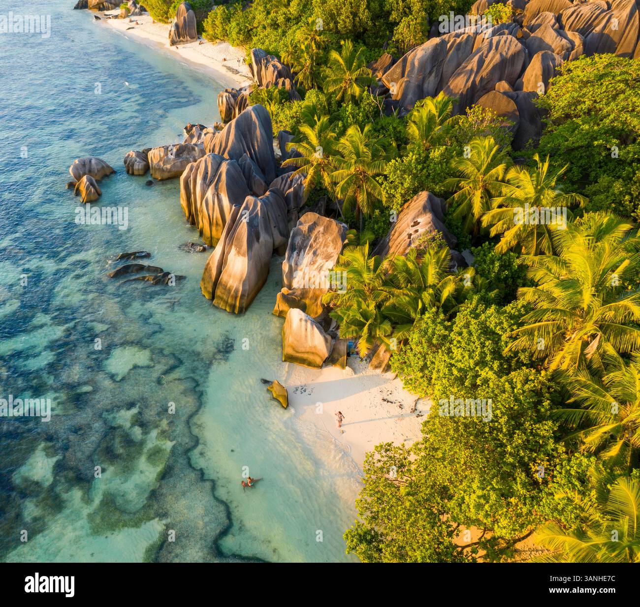 Aerial view of a person with swimsuit at Anse Source d'Argent, a scenic ...