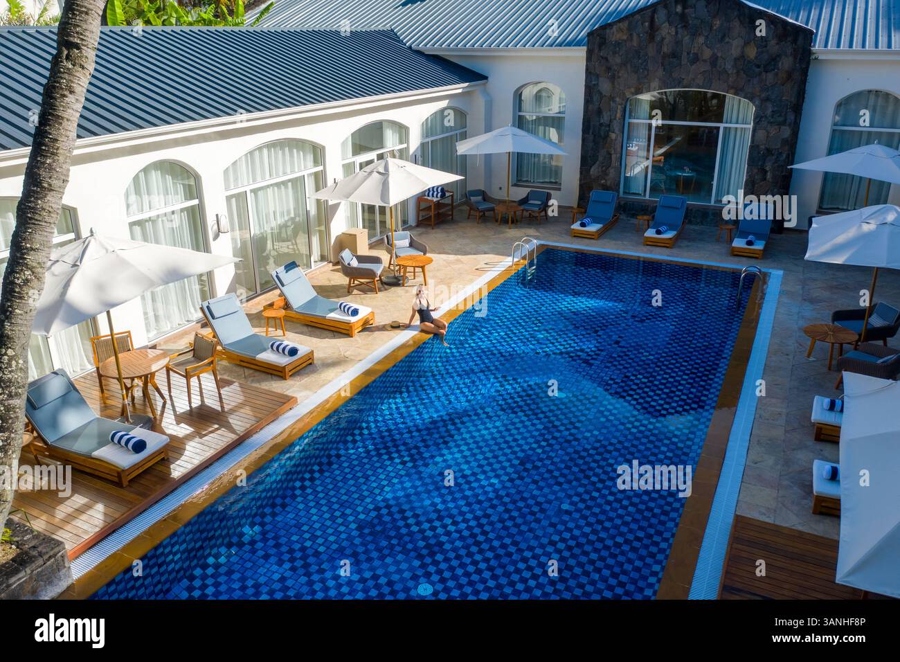 Aerial view of a beautiful woman relaxing in a luxury hotel with ...