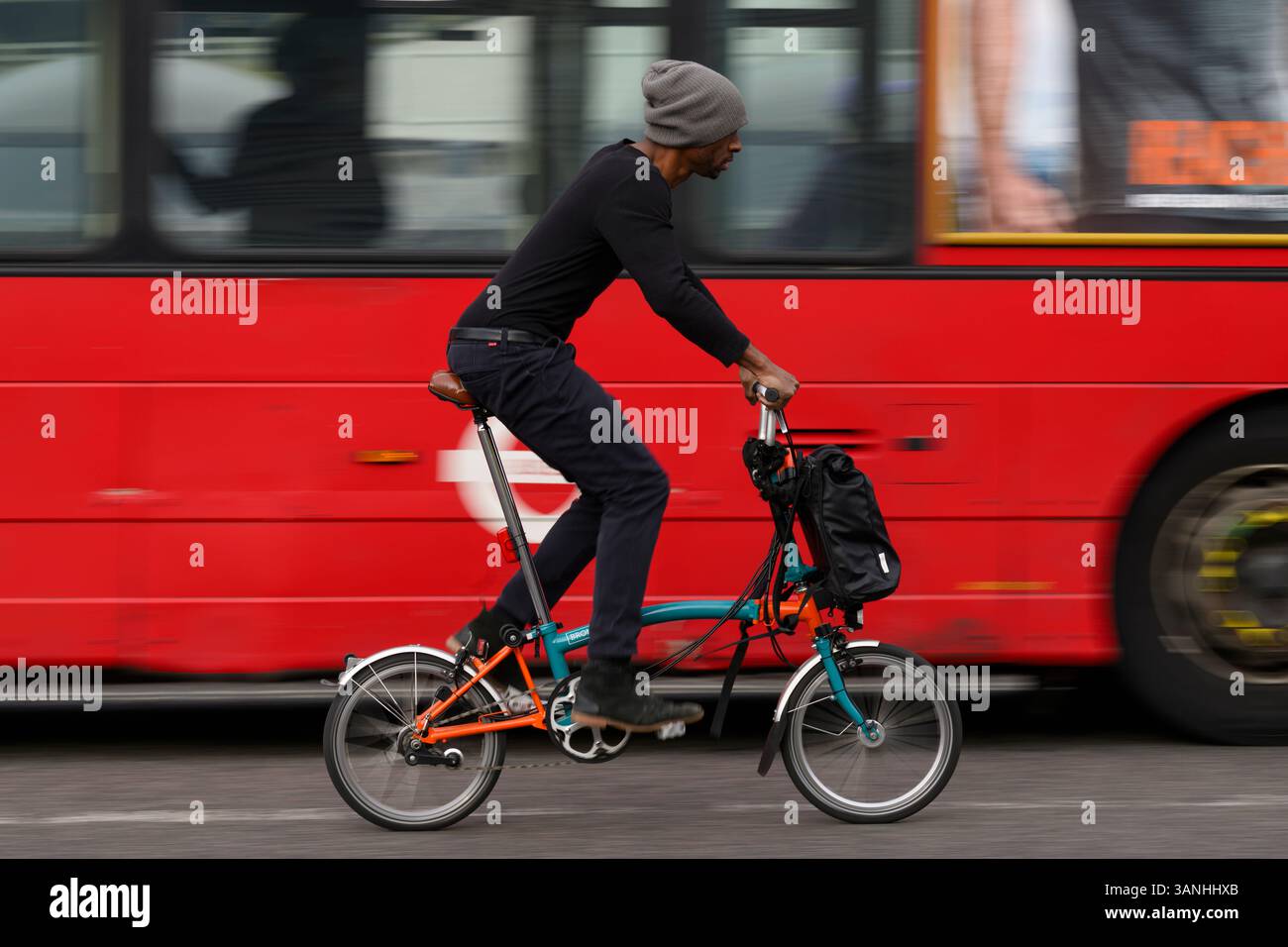 A man riding a Brompton folding bicycle across Waterloo Bridge, London ...