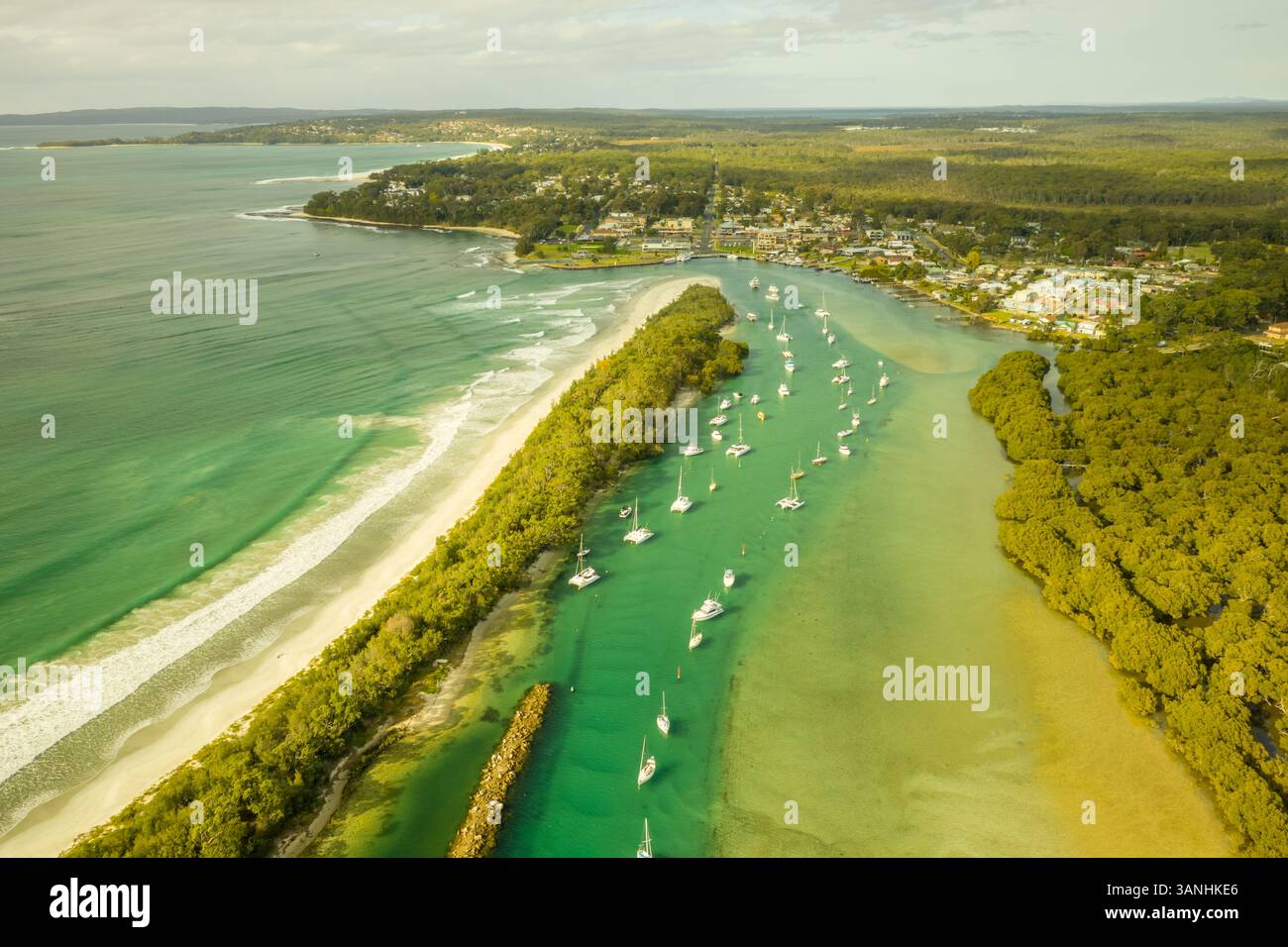 Aerial view of a small boats fleet sailing the Currambene creek at ...